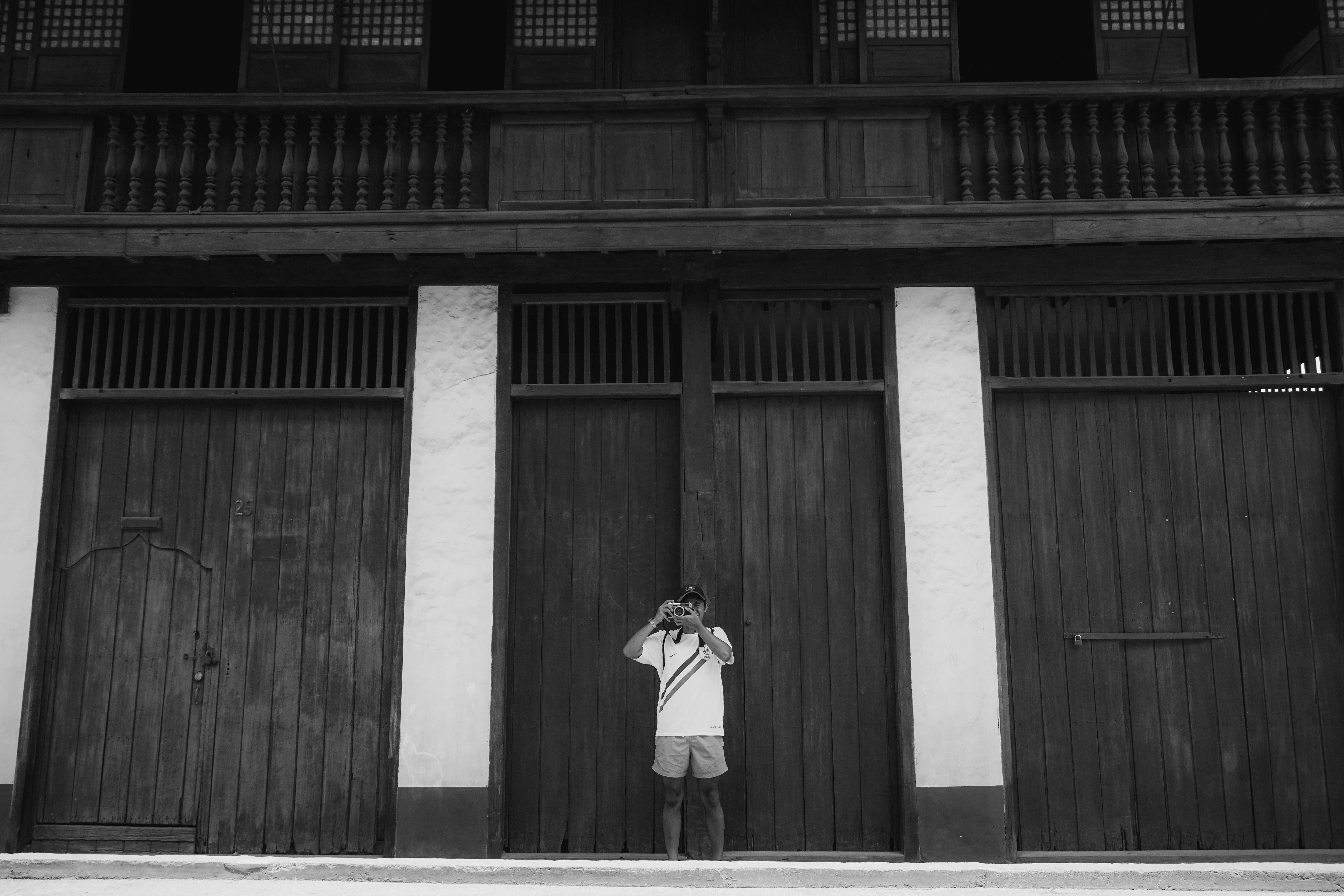 Grayscale Photo of Man Holding Camera · Free Stock Photo