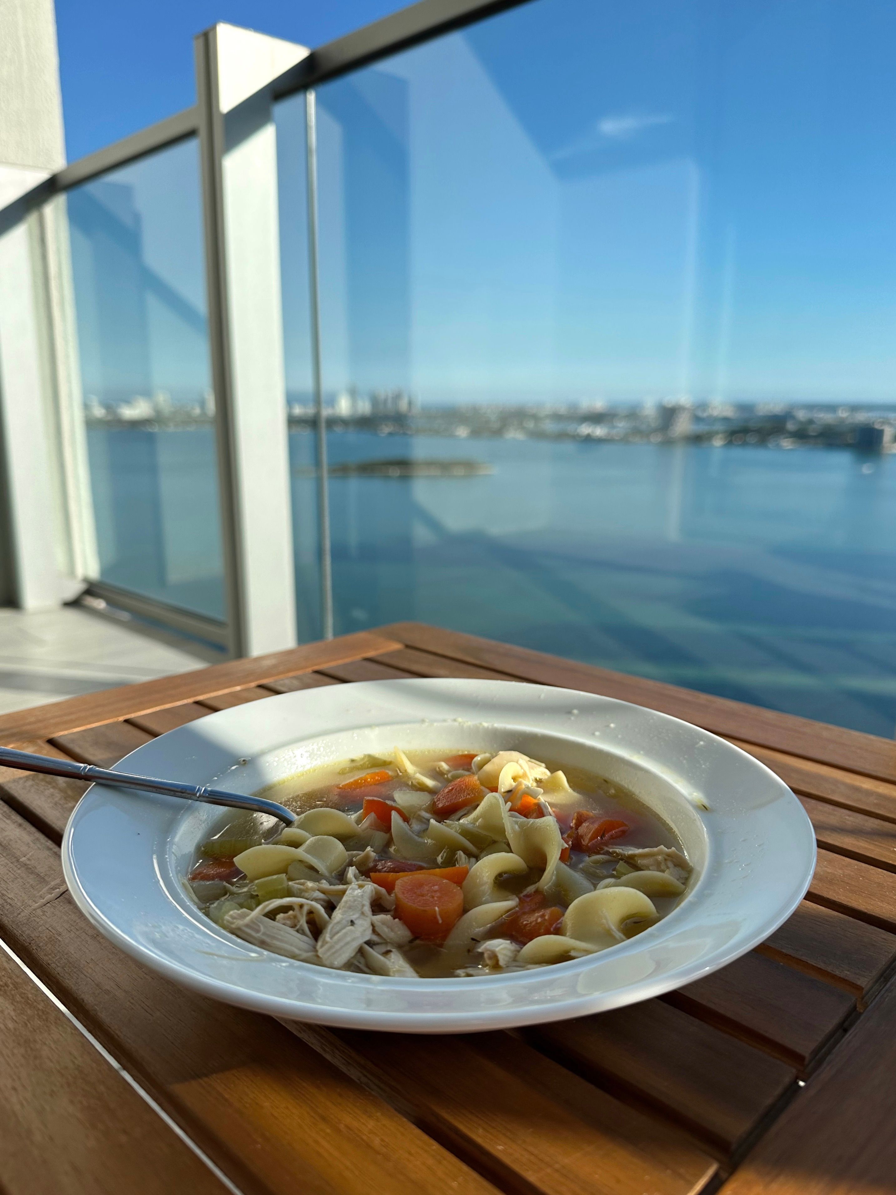 Chicken Noodle Soup with Scenic Balcony View · Free Stock Photo