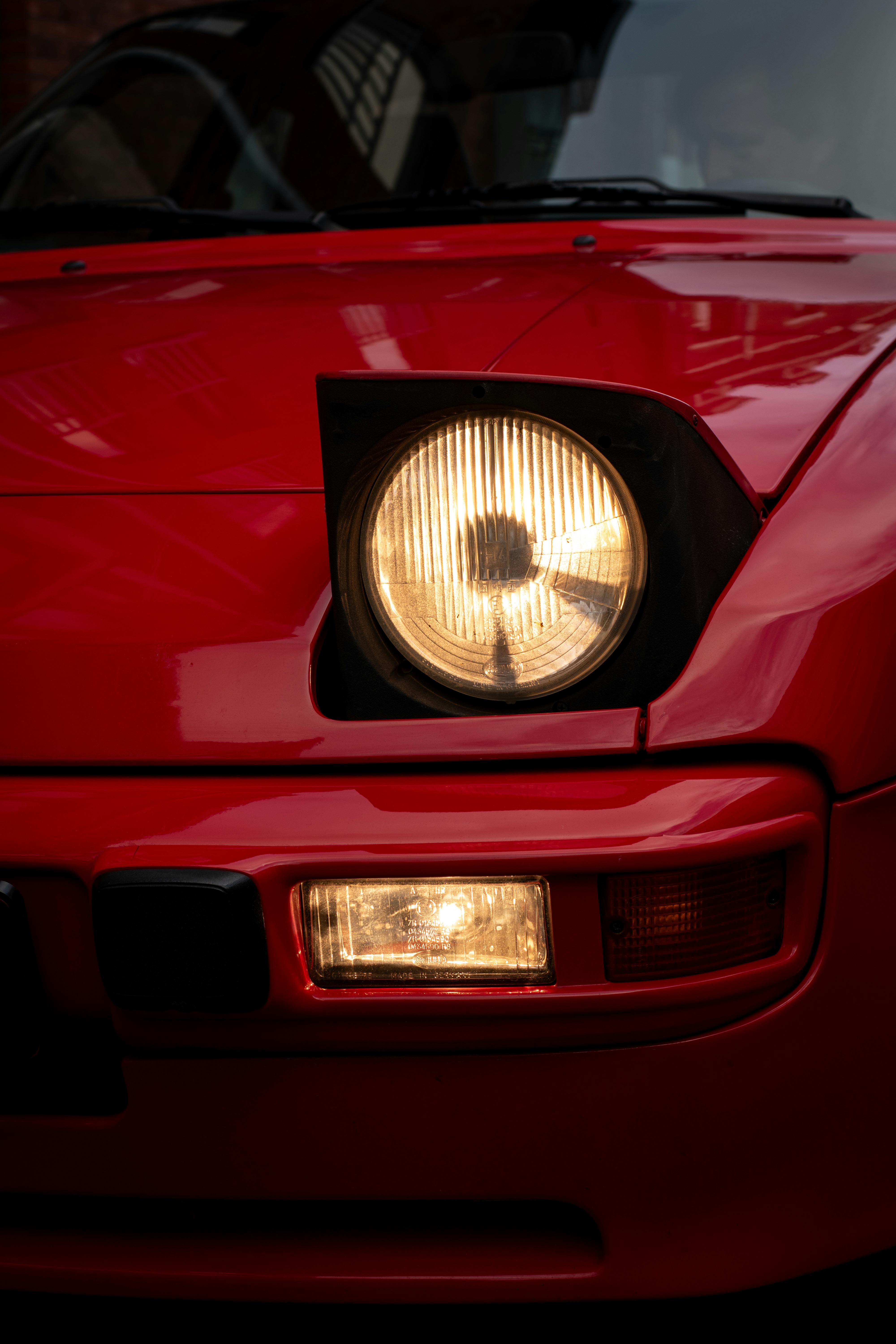 Close-Up of Classic Red Car Headlight · Free Stock Photo