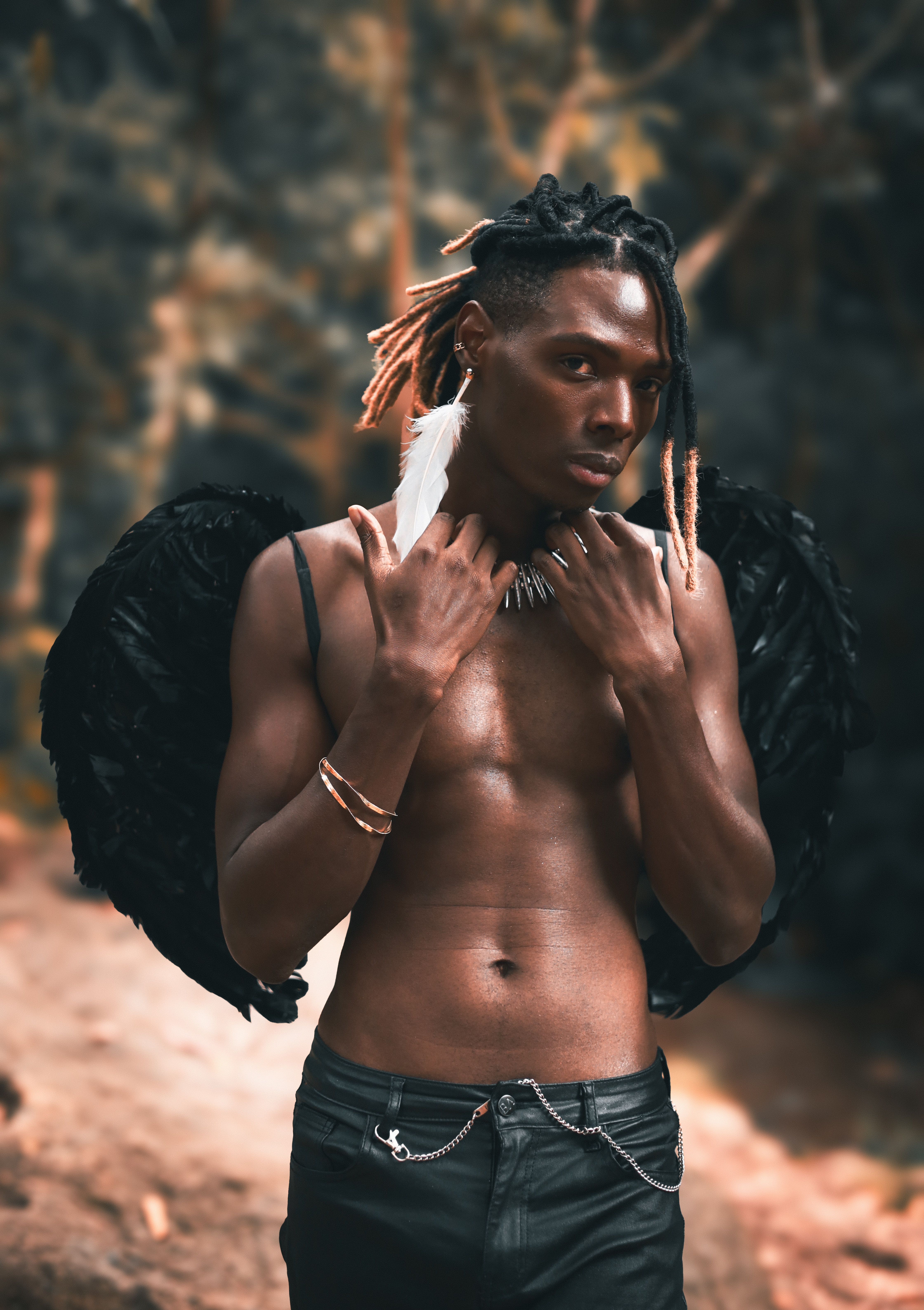 Artistic Portrait of a Man with Black Wings Outdoors · Free Stock Photo