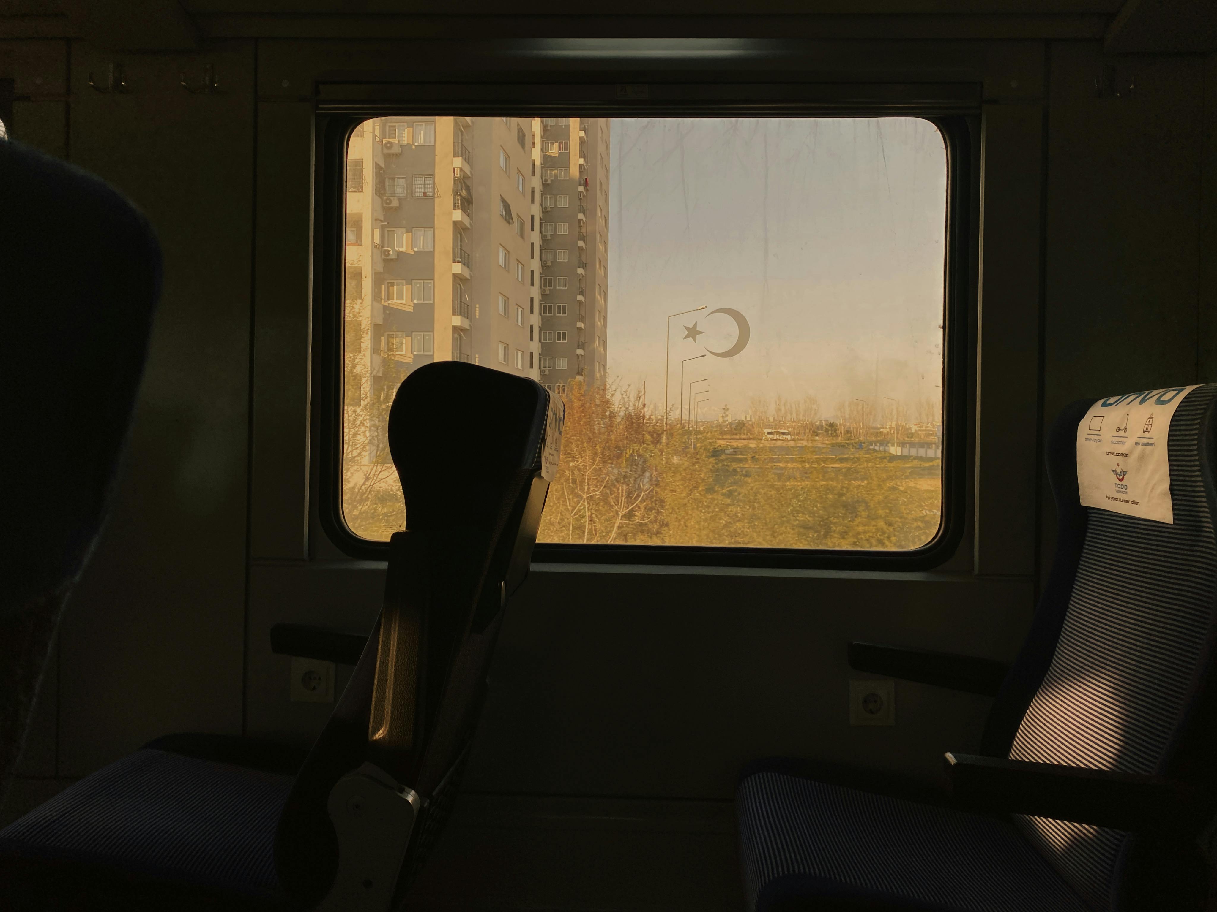 View from Train Window Overlooking Urban Landscape · Free Stock Photo