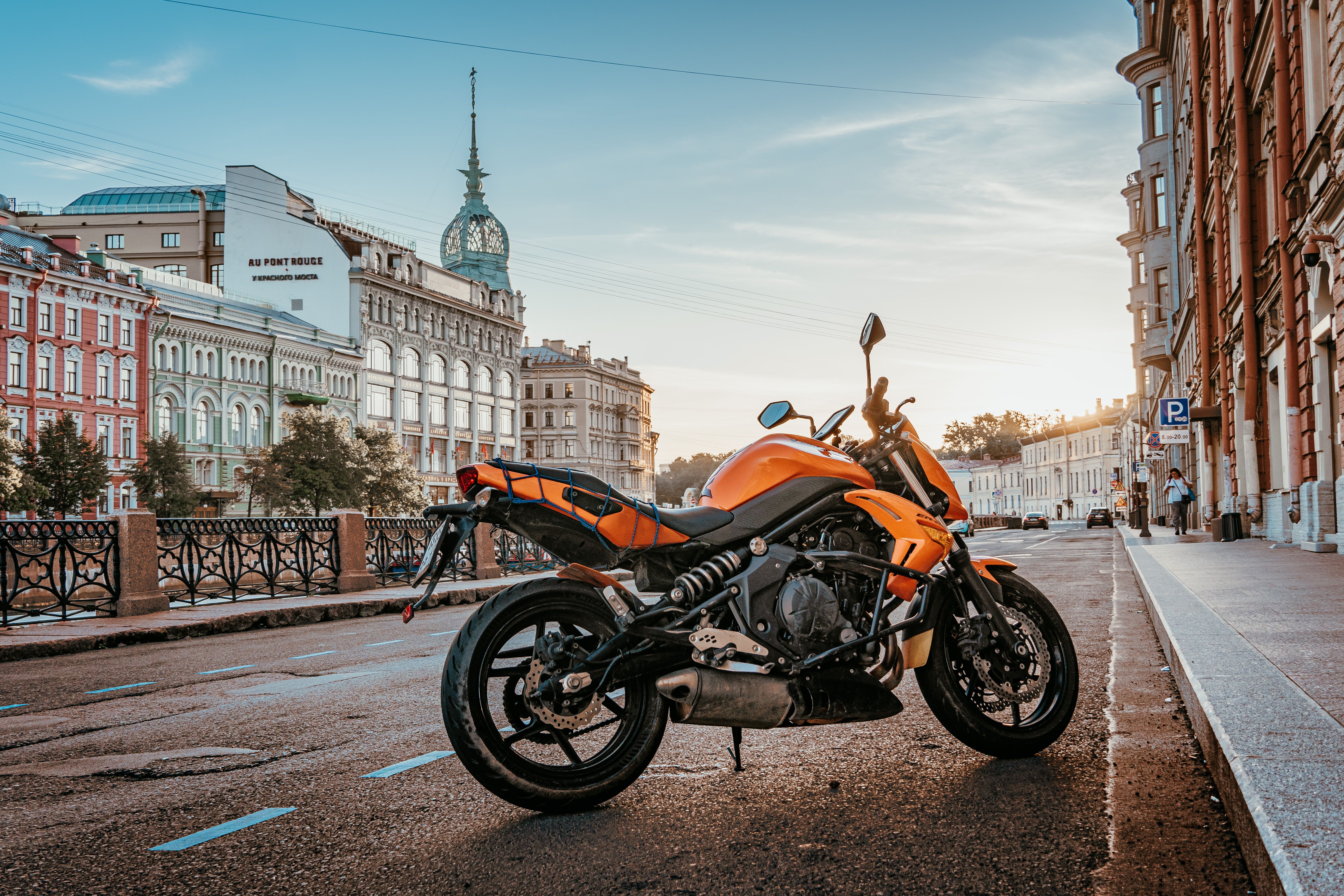 Orange Motorcycle on Historic City Street at Dawn · Free Stock Photo