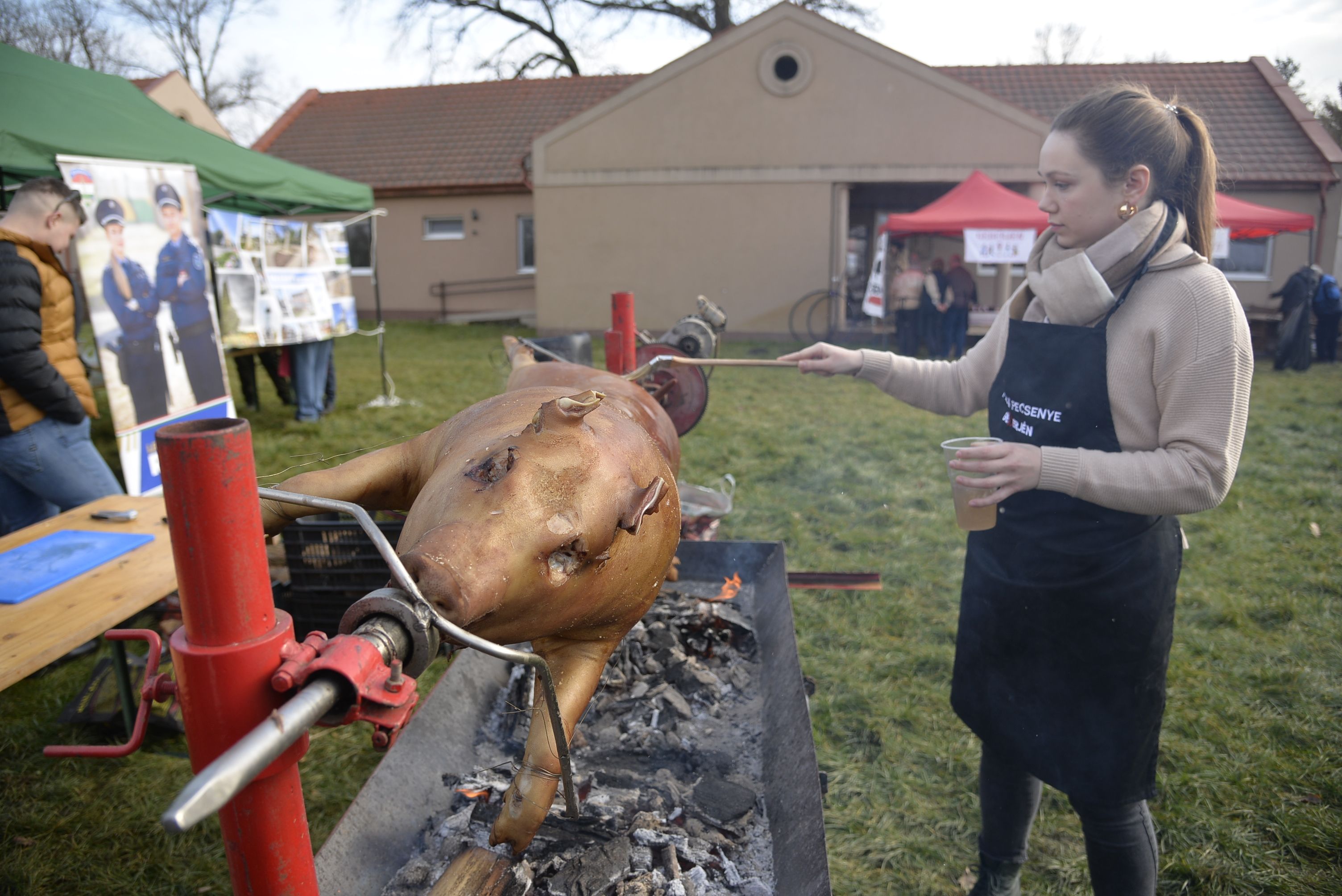 Young Woman Roasting Pig Outdoors in Géberjén · Free Stock Photo