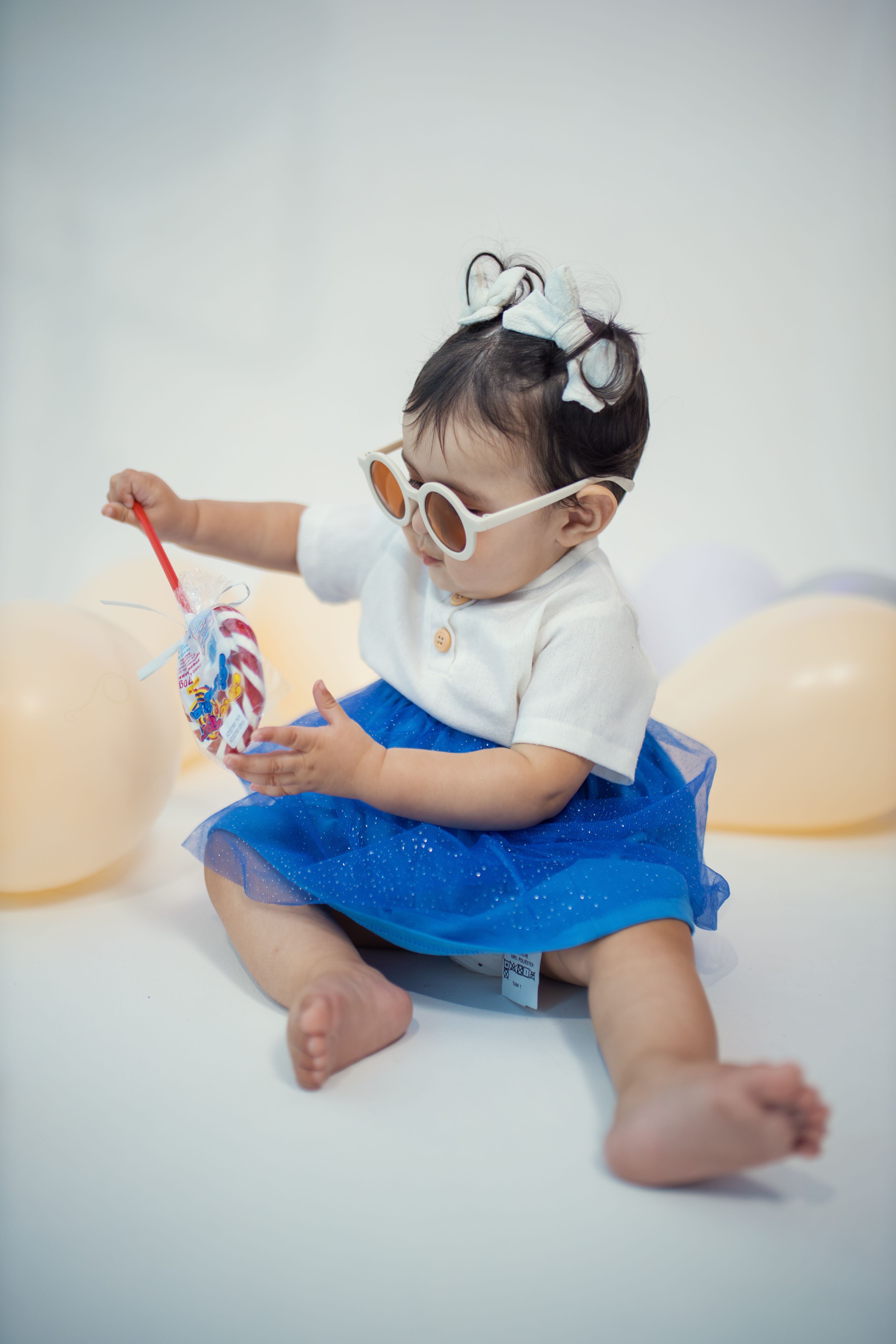 Adorable Baby Celebrating with a Lollipop · Free Stock Photo