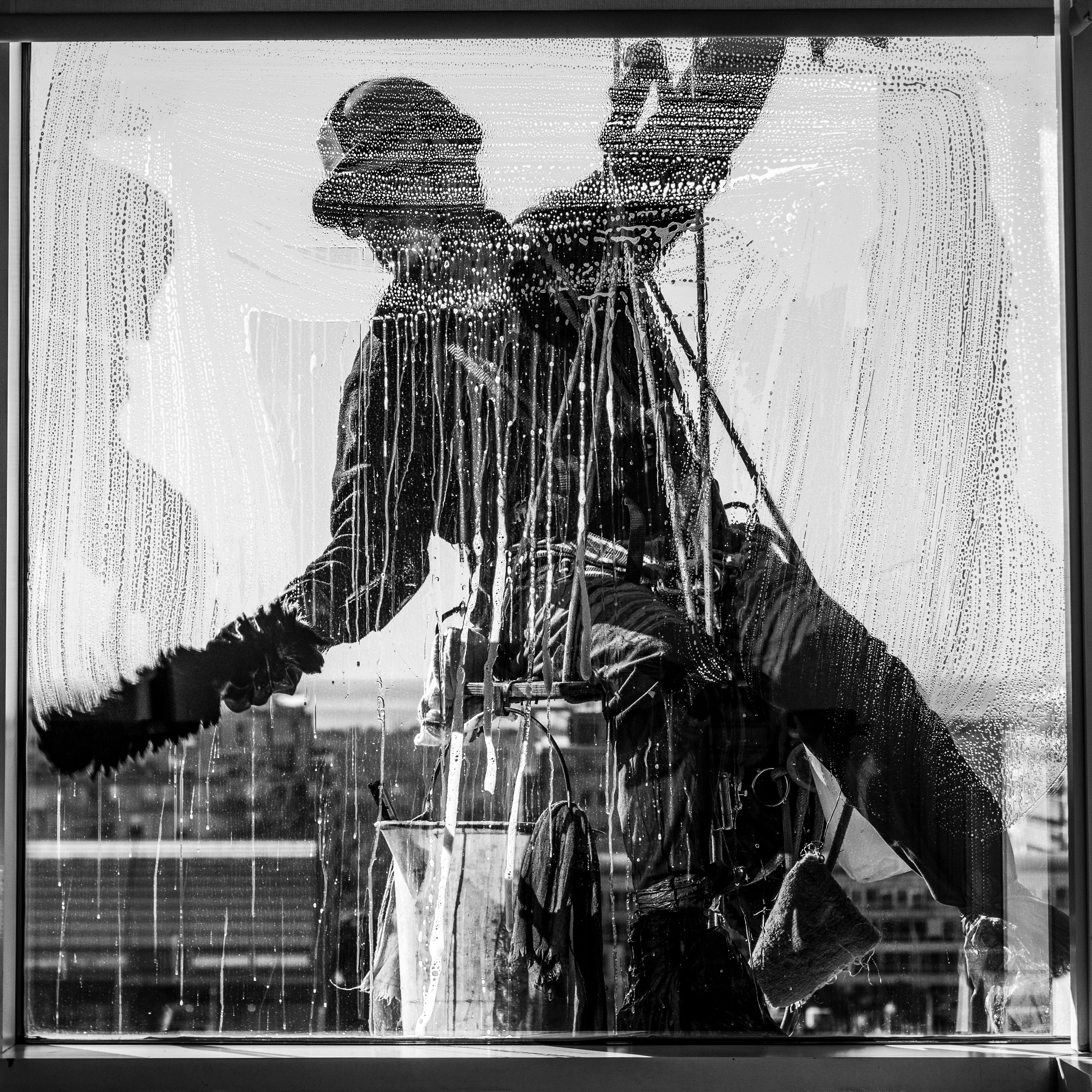 Silhouette of Window Cleaner in Urban Setting · Free Stock Photo