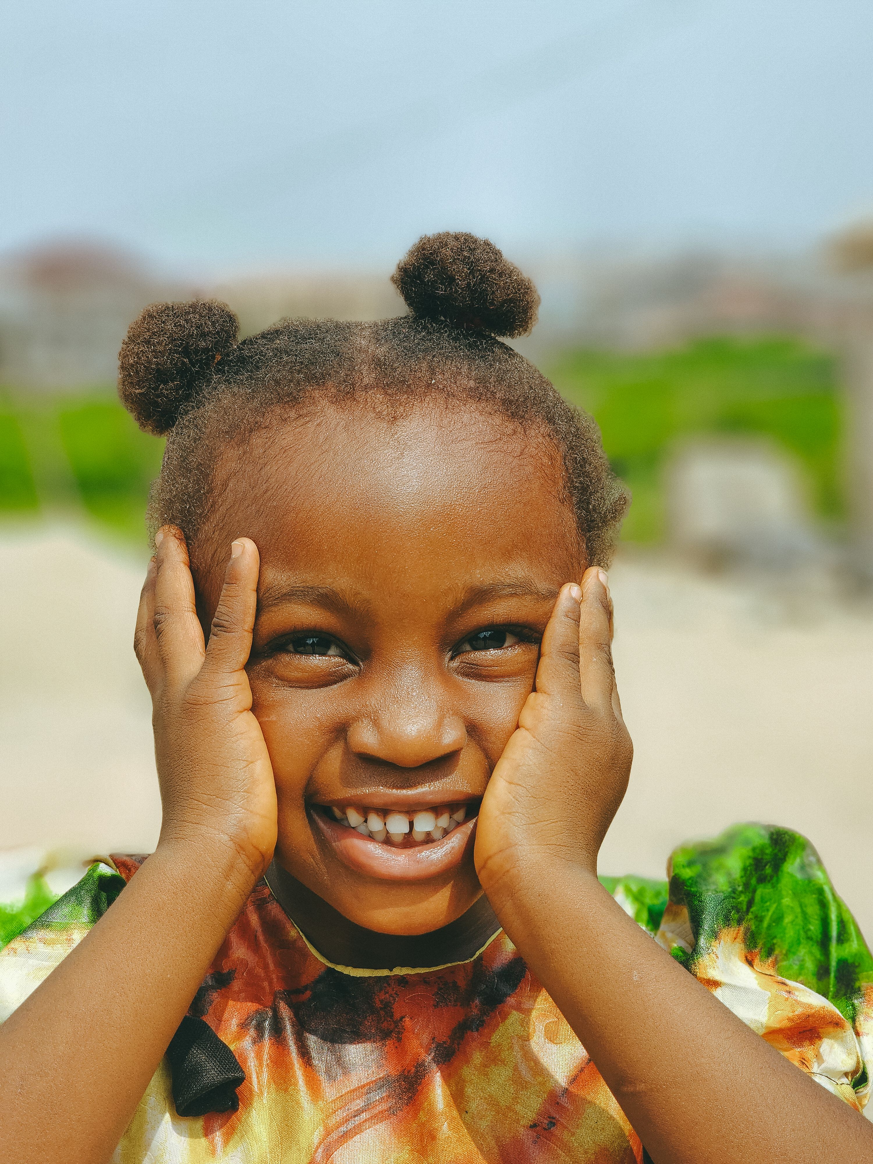 Cheerful Child Smiling Outdoors in Sunny Weather · Free Stock Photo