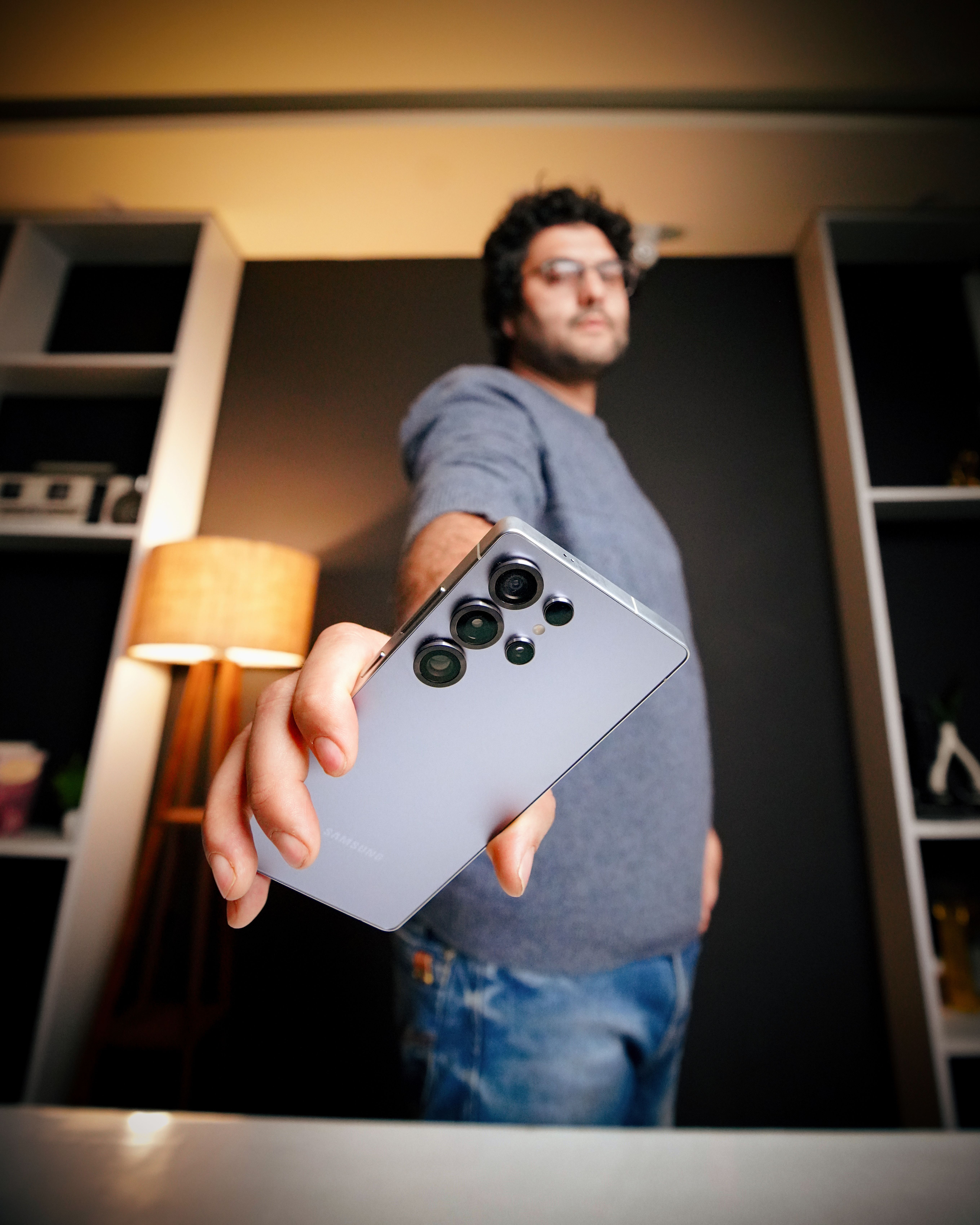 Man Handing Over Smartphone in Modern Office · Free Stock Photo