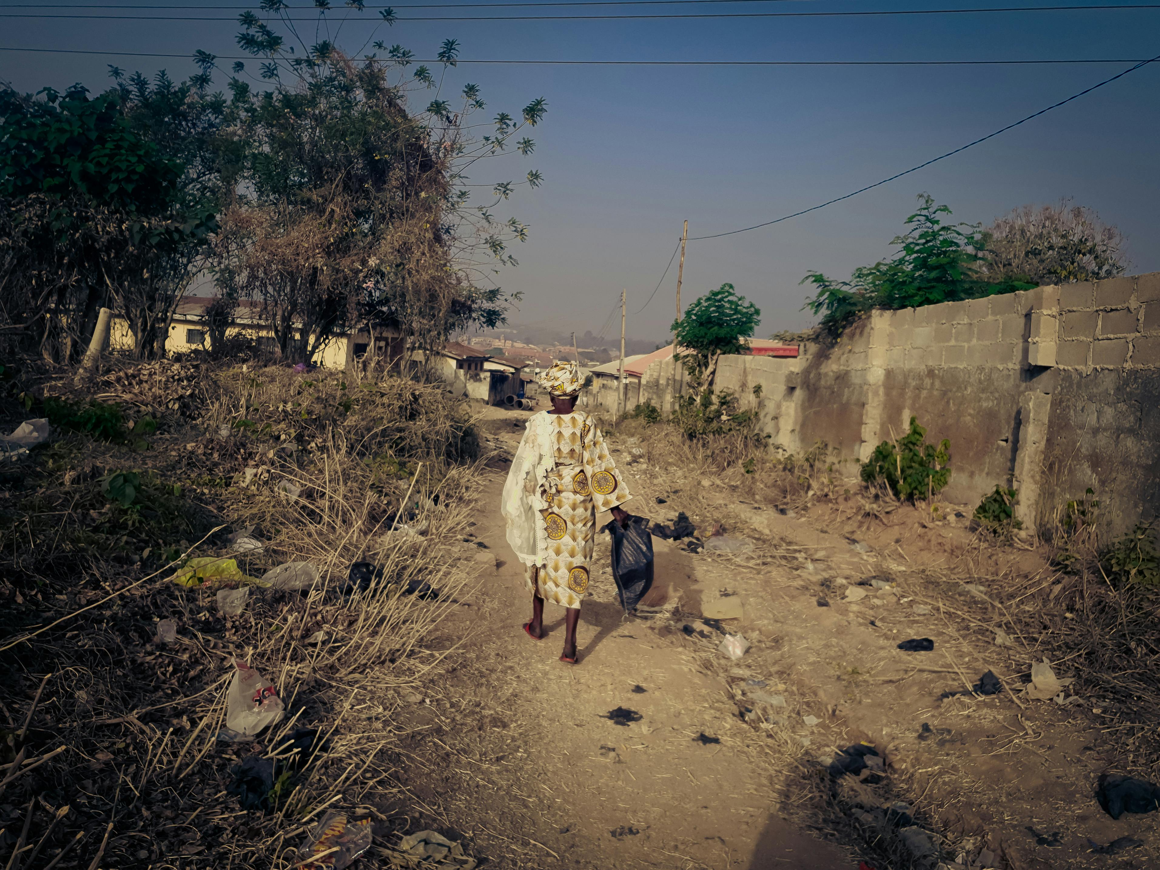 African Woman Walking in Rural Nigerian Pathway · Free Stock Photo