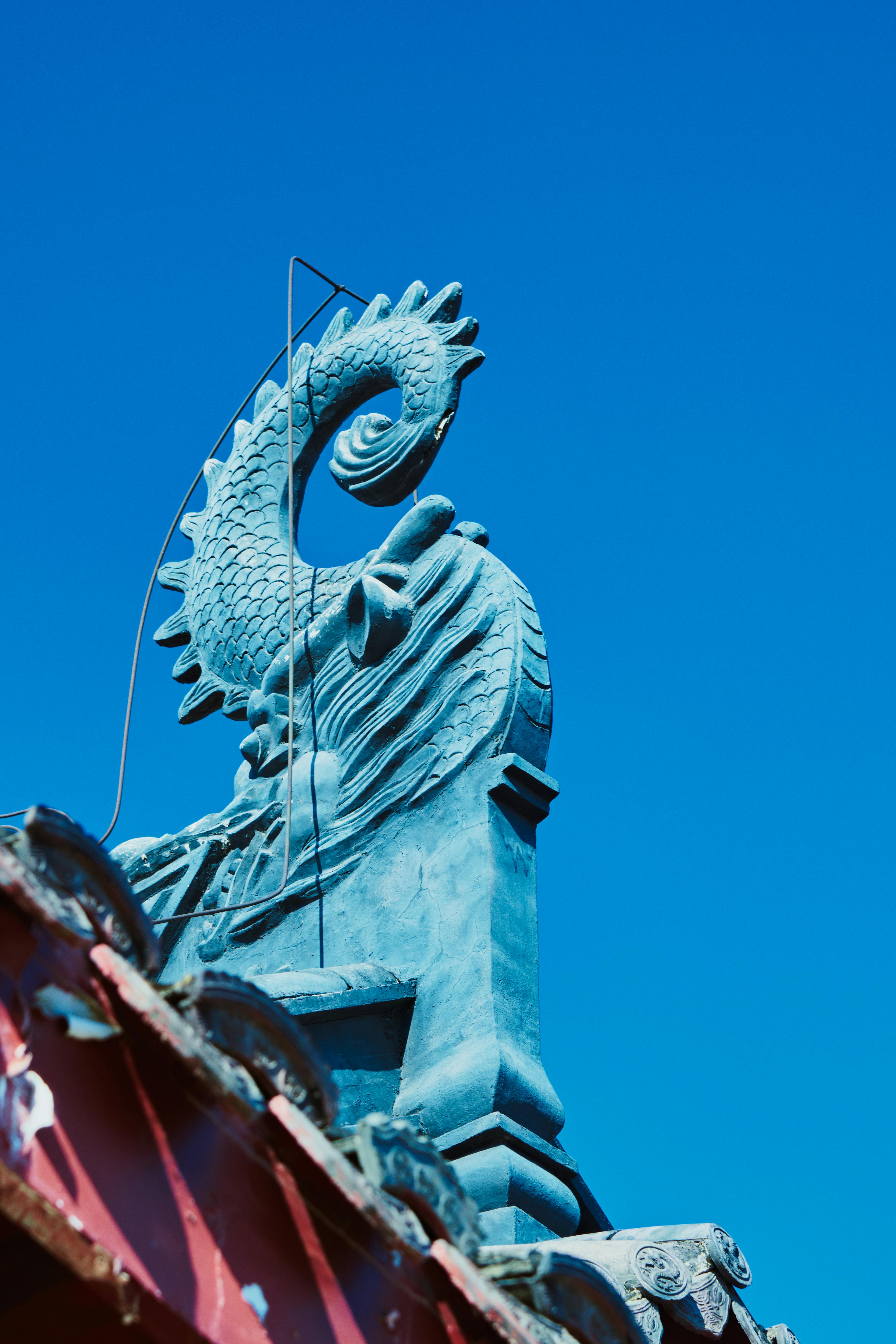 Intricate Dragon Sculpture on Traditional Rooftop · Free Stock Photo