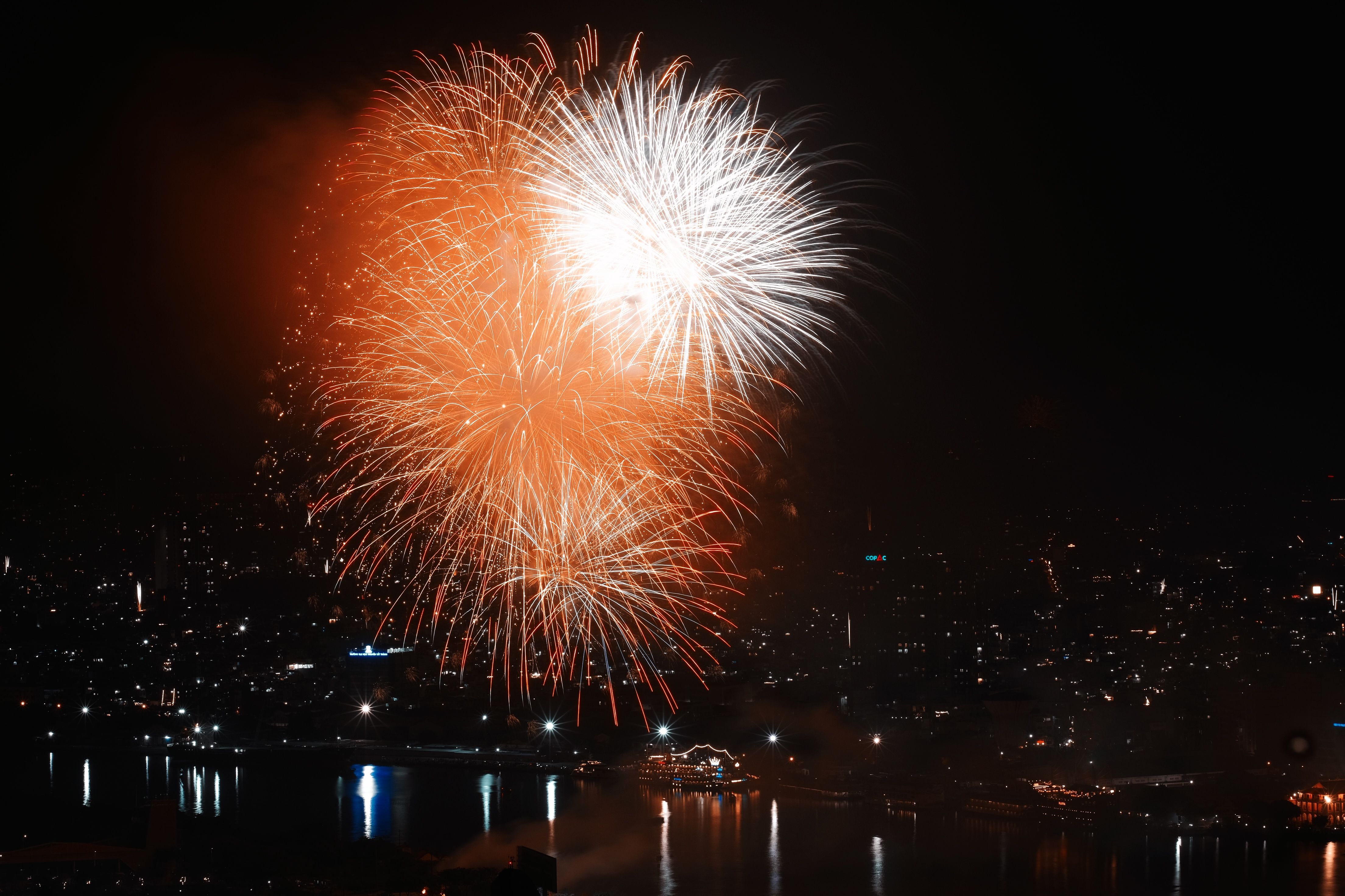 Vibrant Fireworks Over Cityscape at Night · Free Stock Photo