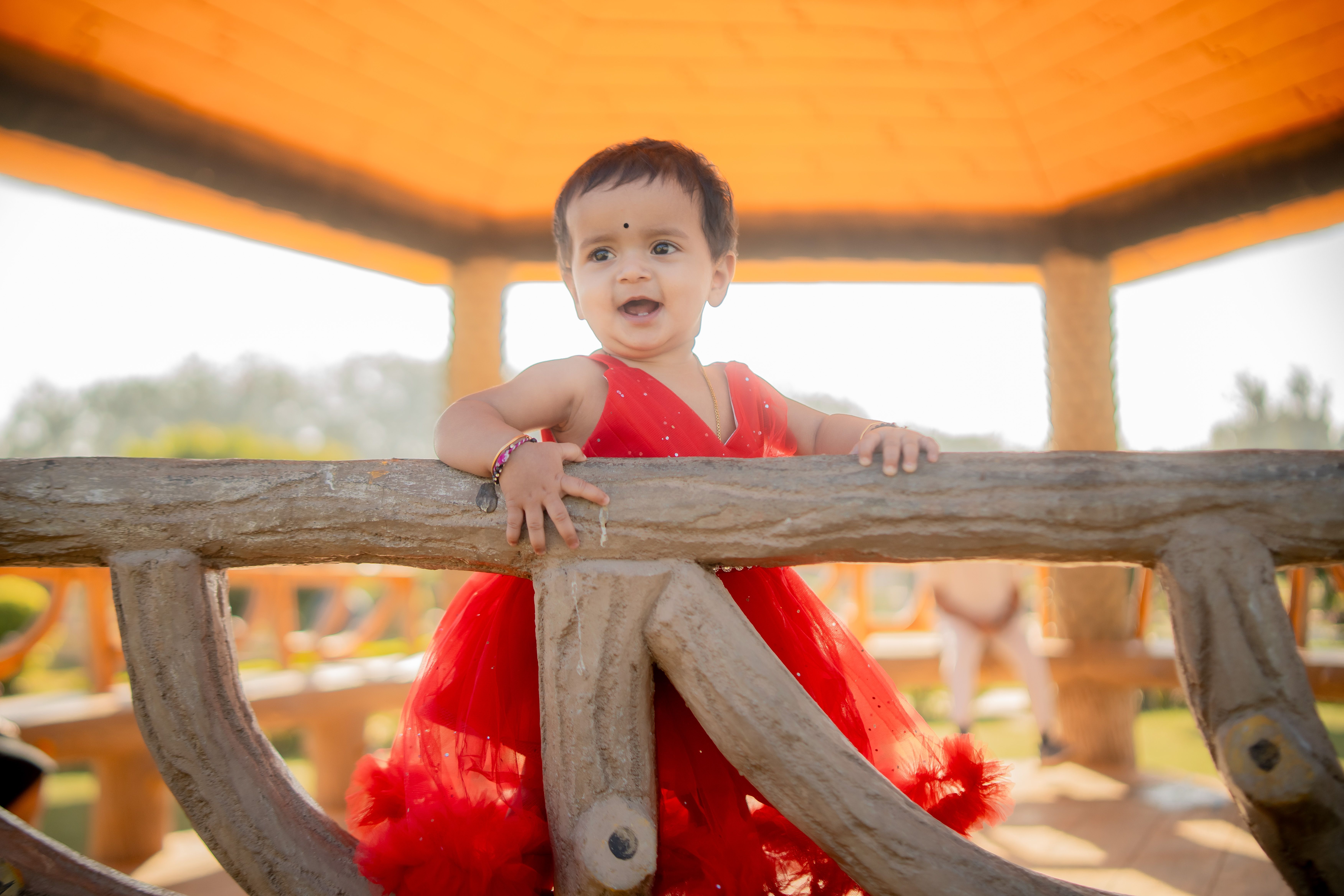 Adorable Baby in Red Dress Outdoors · Free Stock Photo