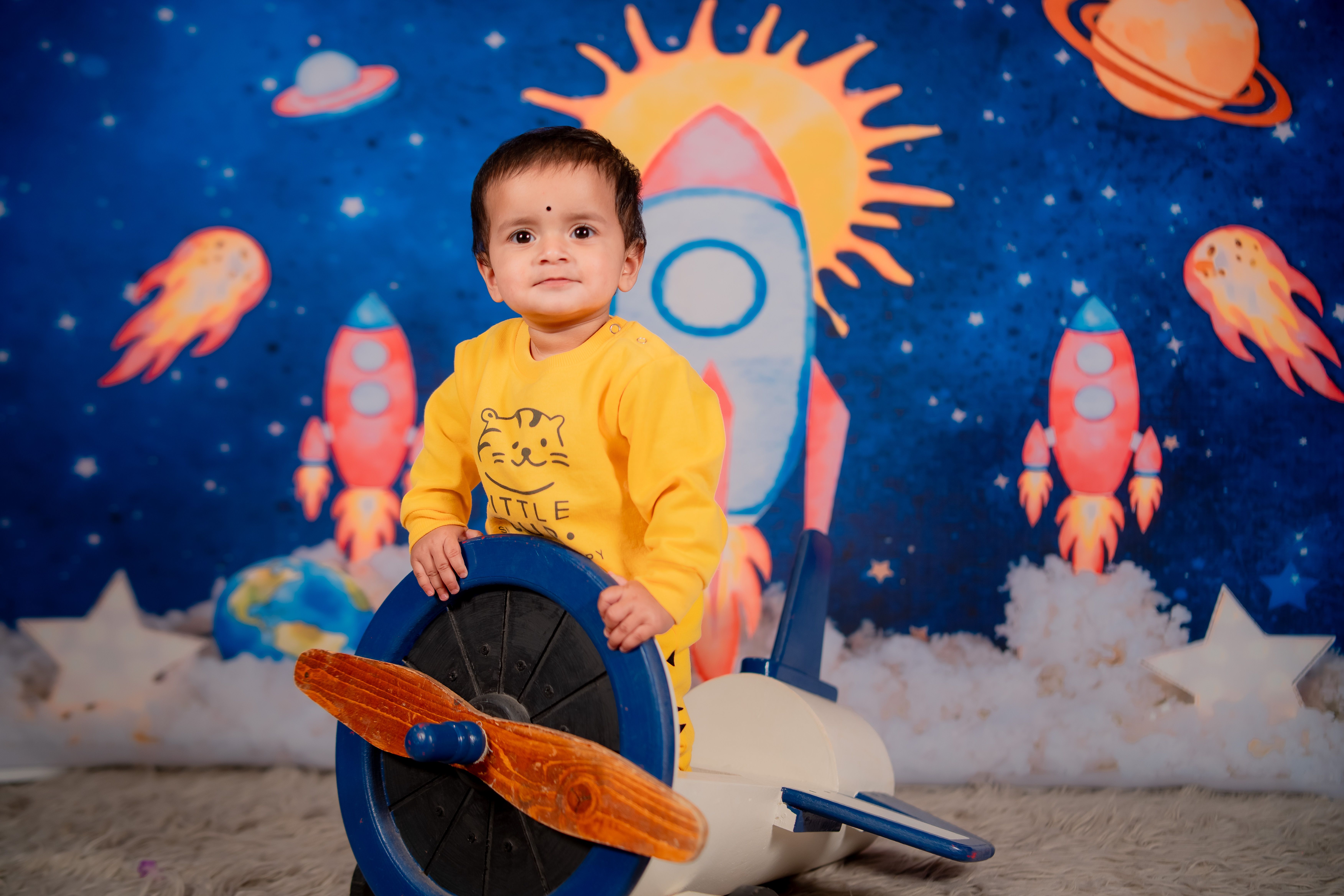 Space-Themed Baby Portrait with Rocket Decor · Free Stock Photo