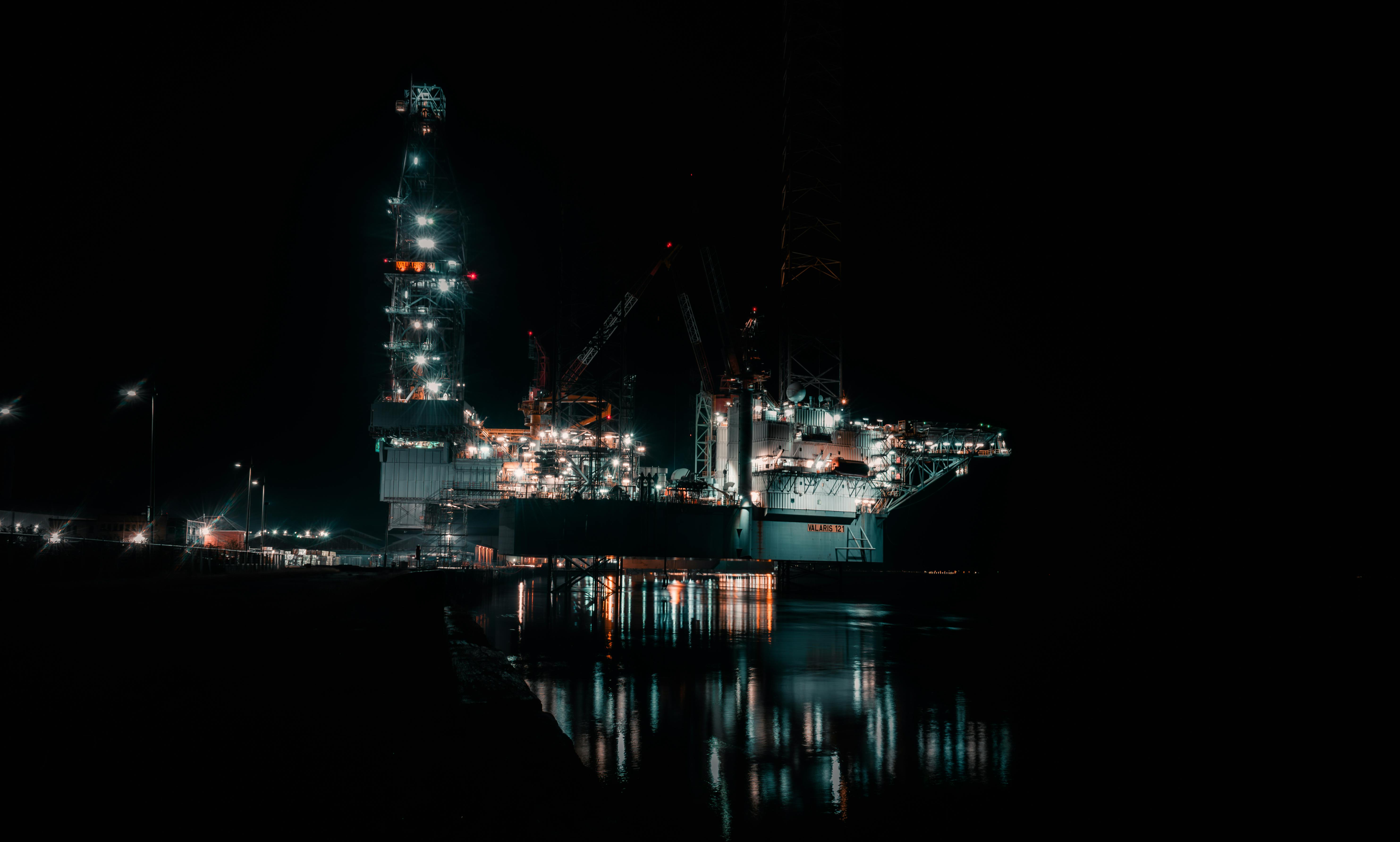 Illuminated Offshore Oil Rig at Night · Free Stock Photo