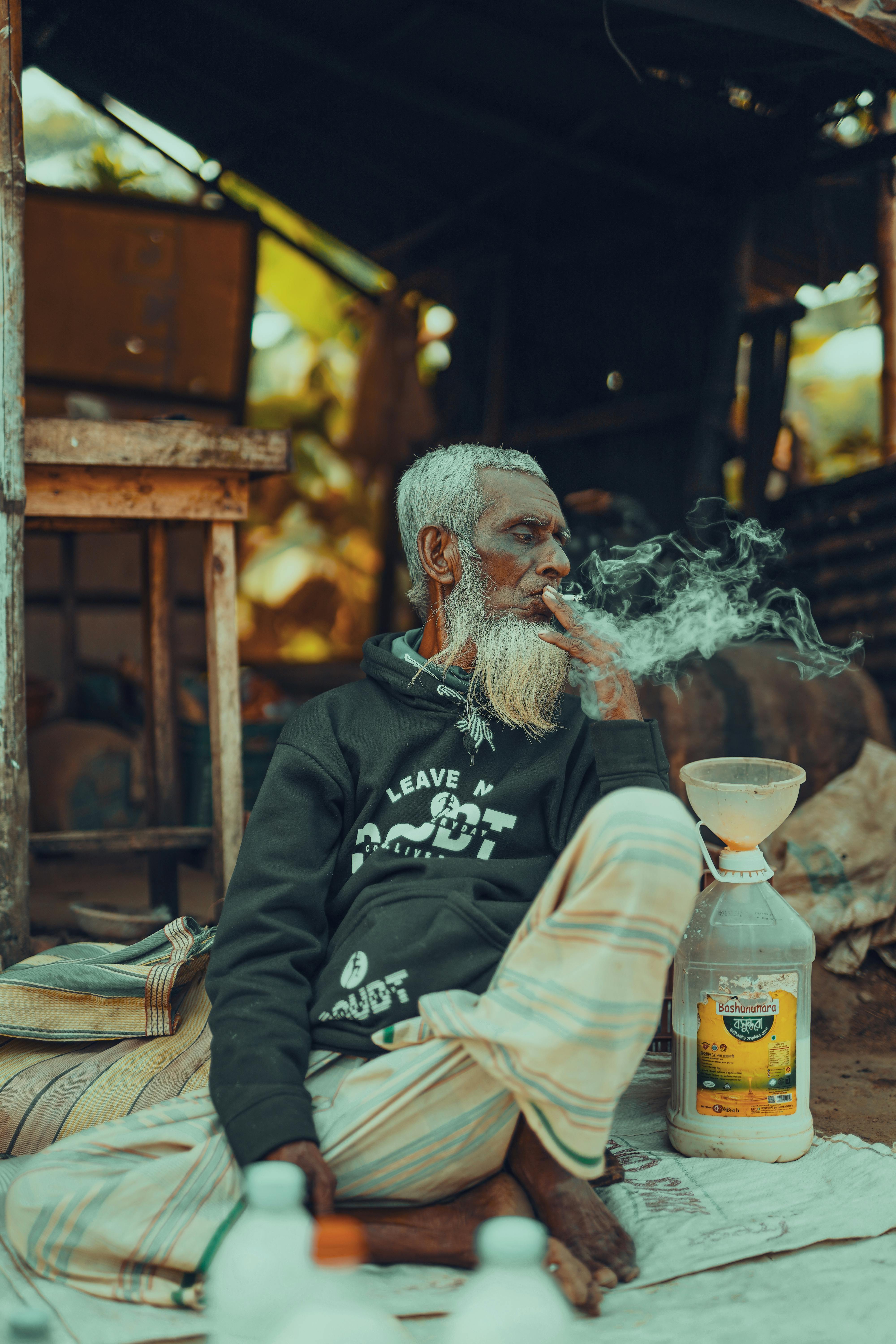 Elderly Man Smoking in a Café in Bangladesh · Free Stock Photo