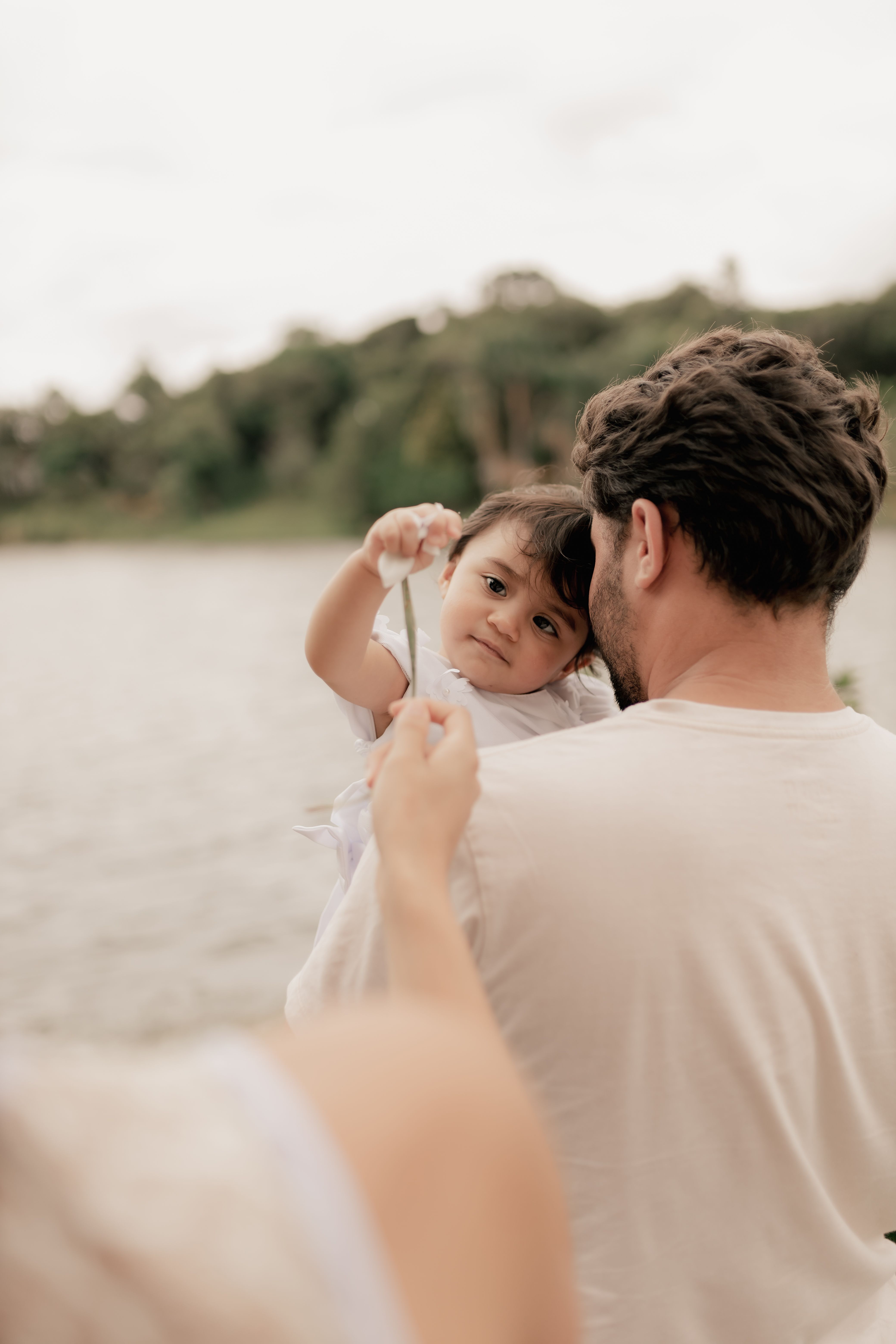 Father and Child Bonding by a Serene River · Free Stock Photo