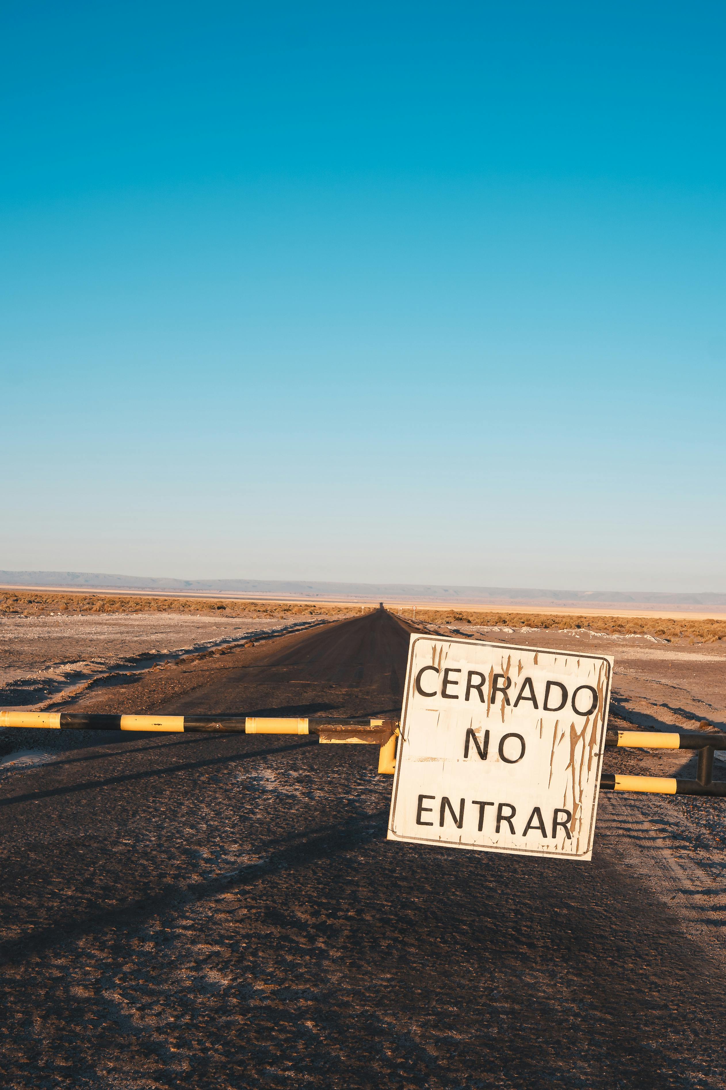 Desert Road Closed with Warning Sign · Free Stock Photo