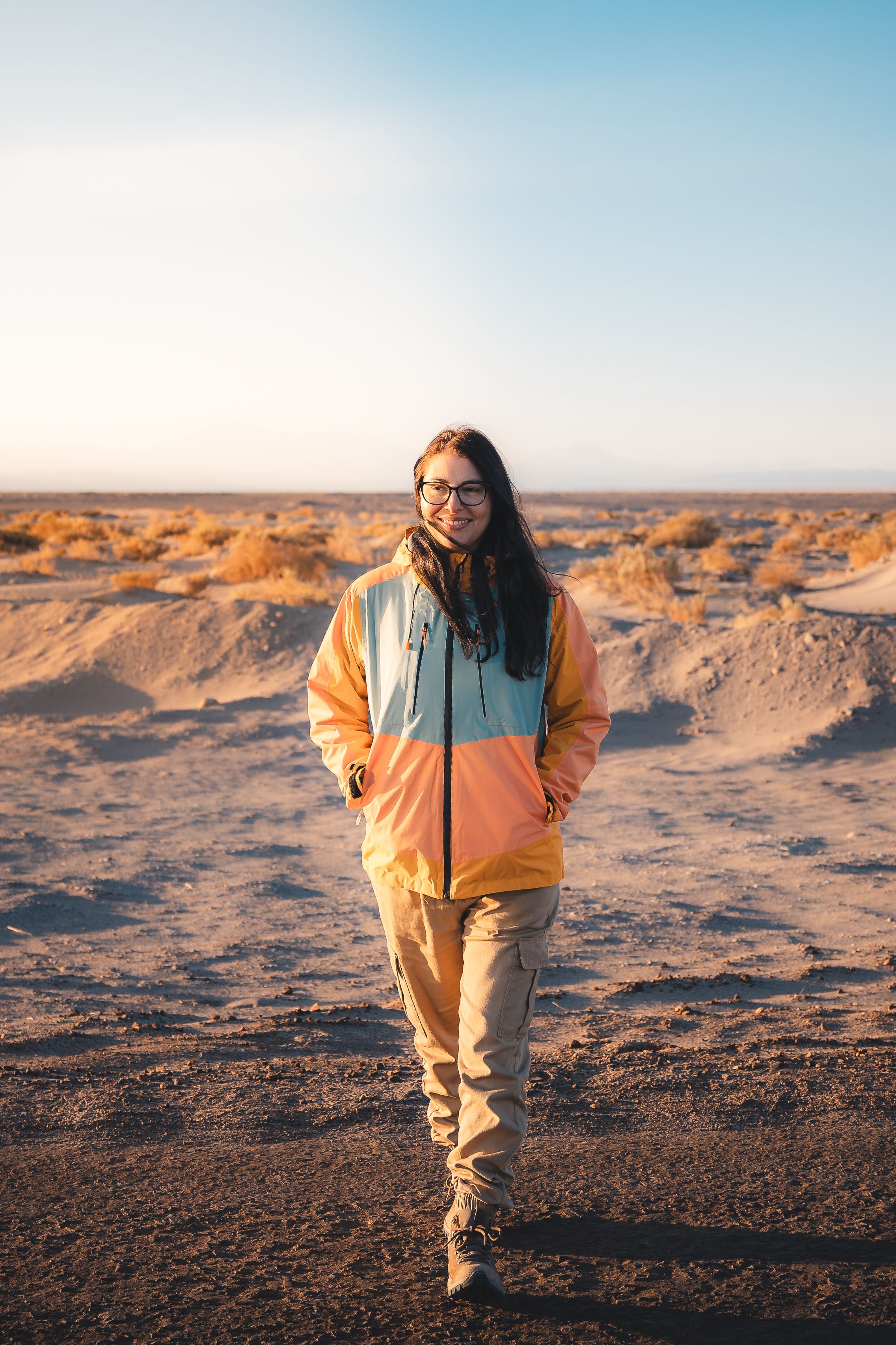 Woman exploring vast desert landscape at sunset · Free Stock Photo