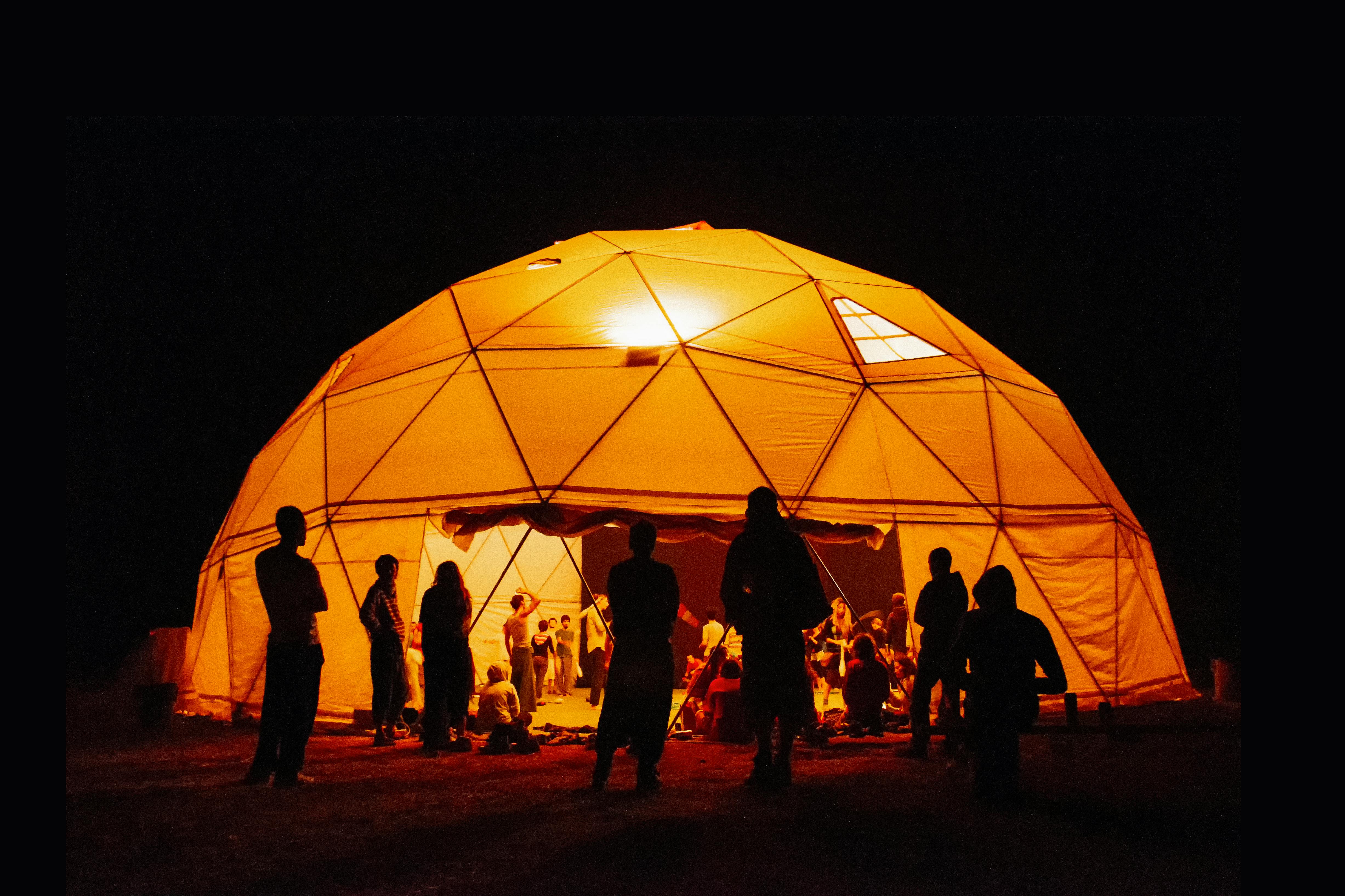 Night Gathering in Illuminated Geodesic Dome · Free Stock Photo