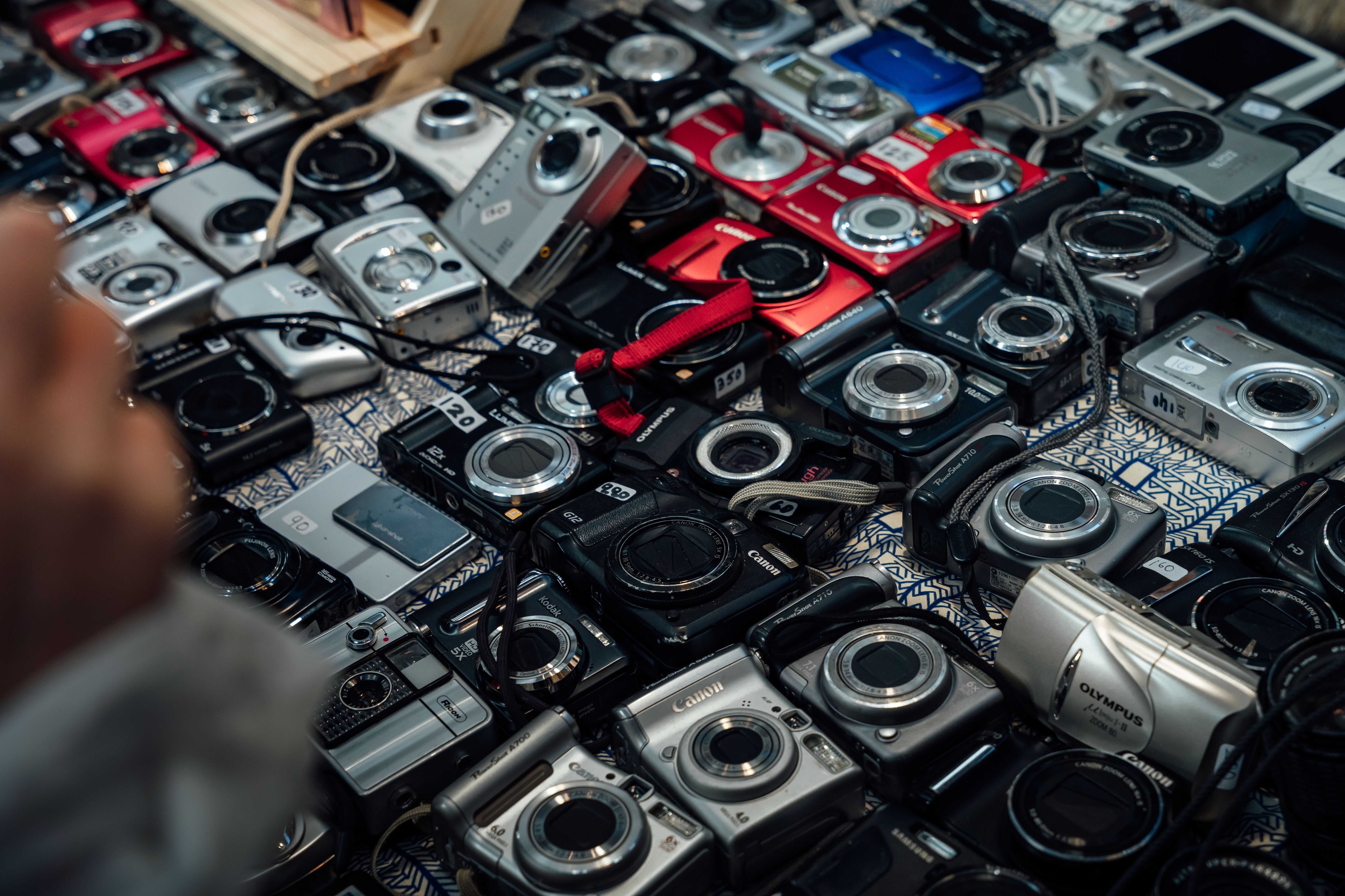 Collection of Vintage Cameras on Display Table · Free Stock Photo