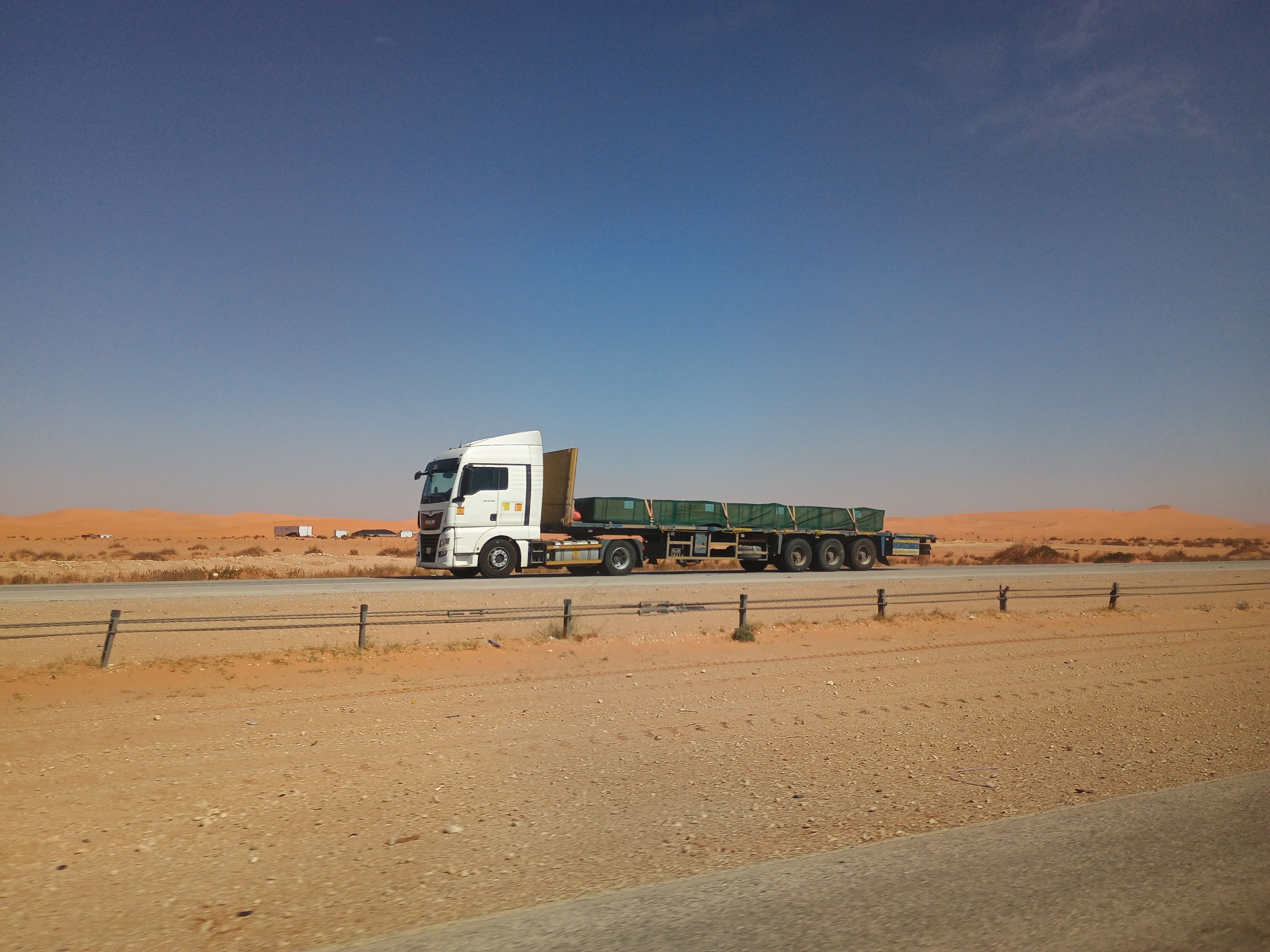 Truck Traveling Through Desert in Saudi Arabia · Free Stock Photo
