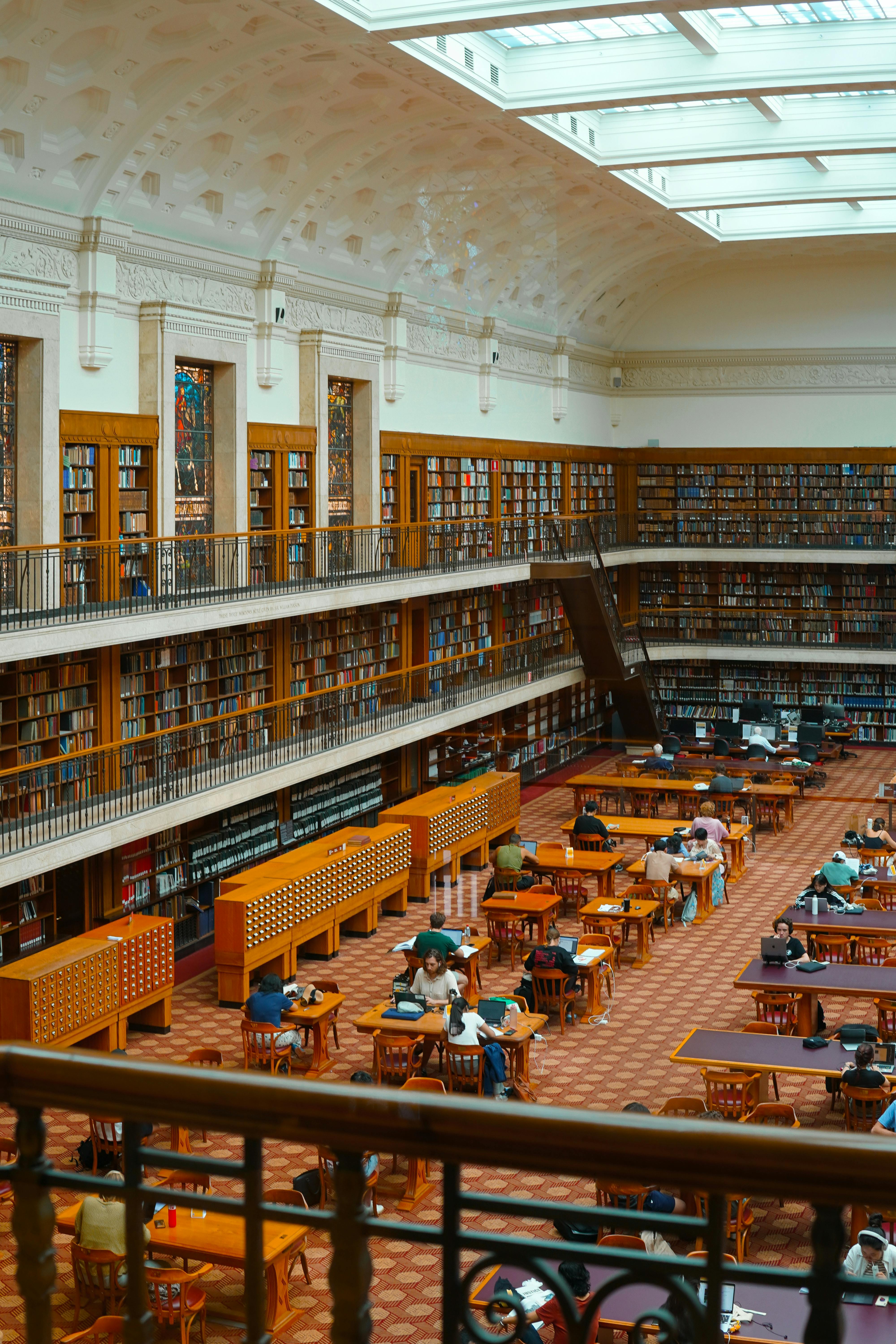 Spacious Library Interior with People Reading · Free Stock Photo