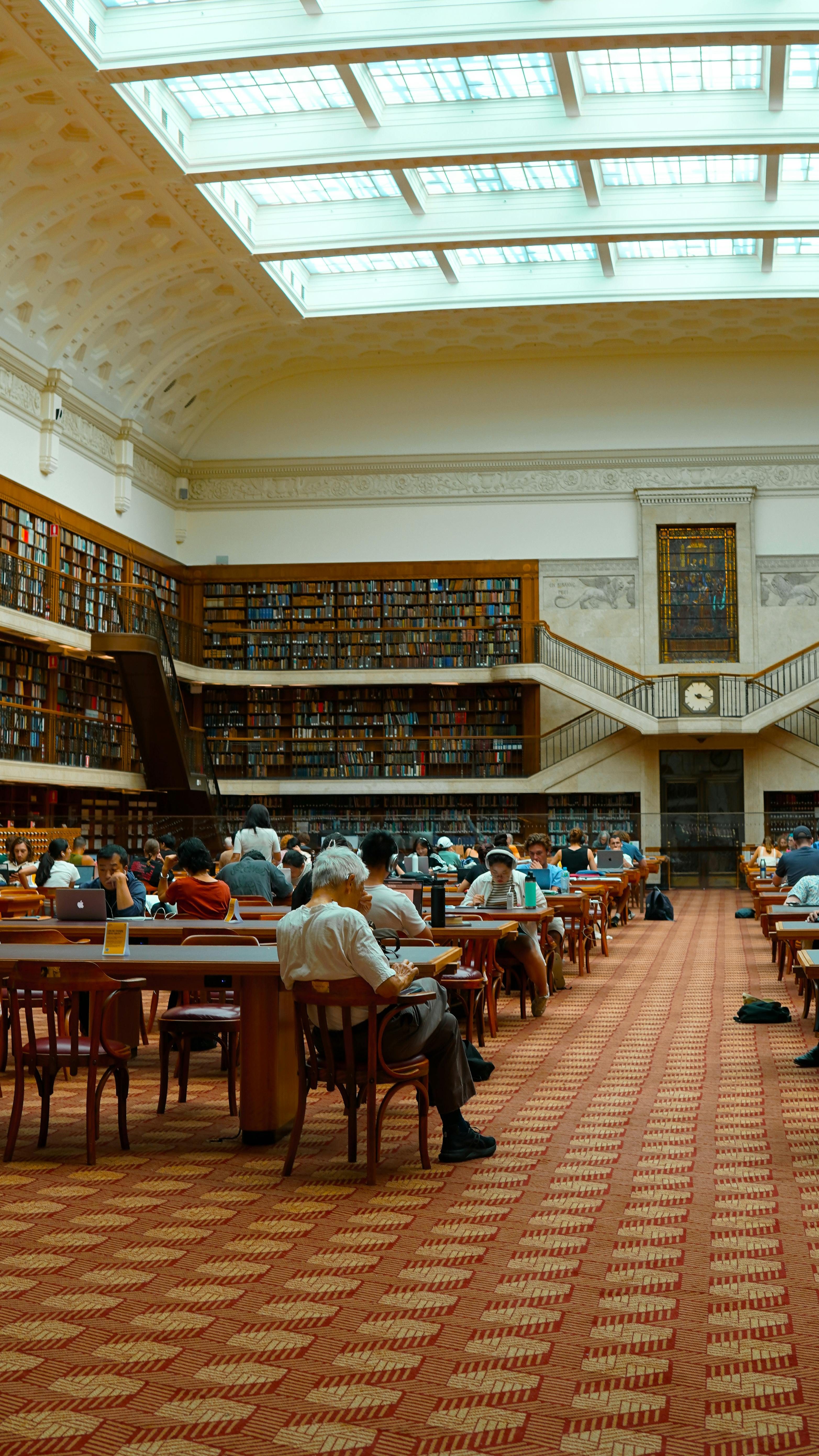 People at Library Sitting Down at Tables · Free Stock Photo