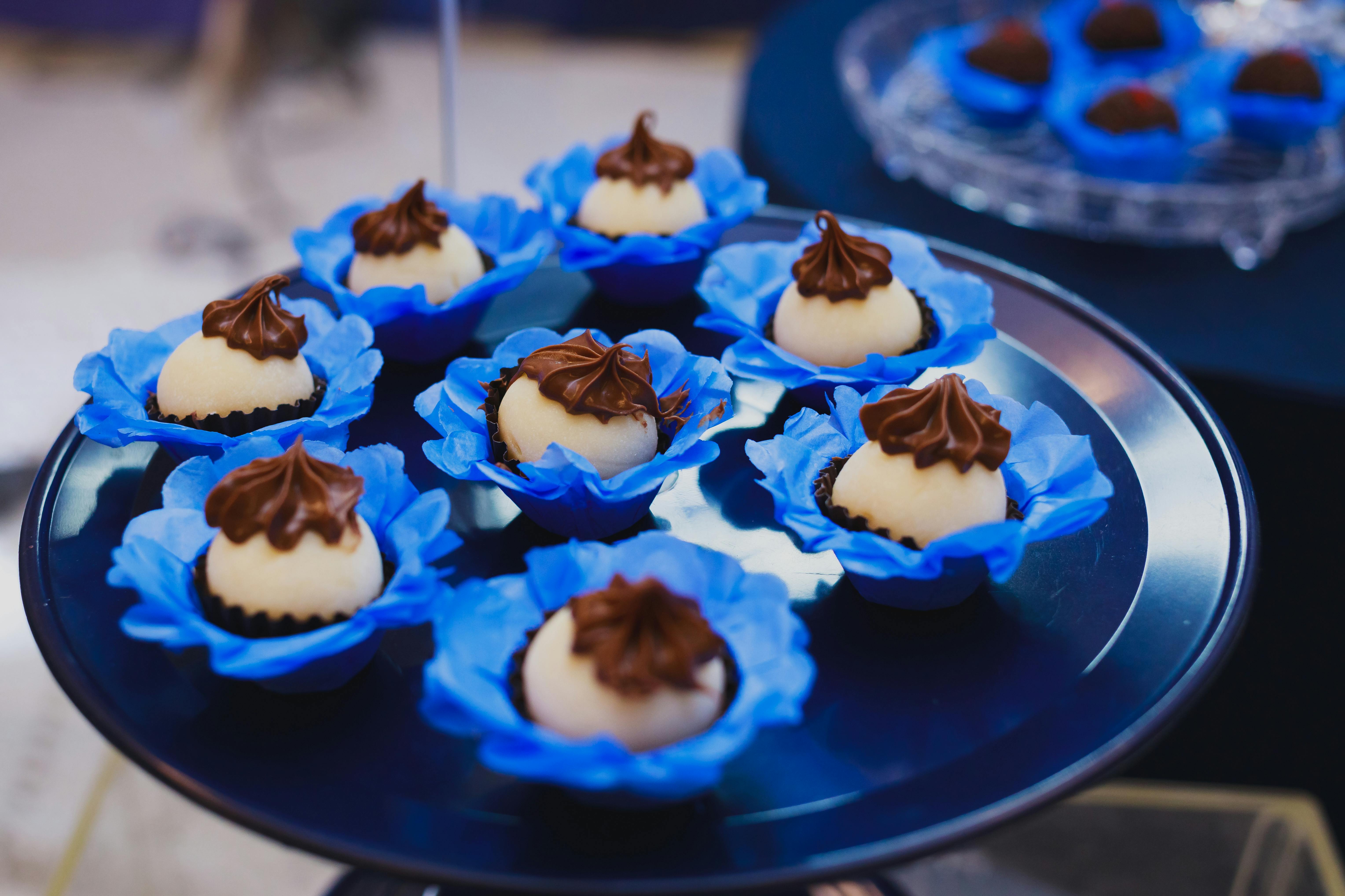 Chocolate Topped Sweets in Blue Wrappers · Free Stock Photo