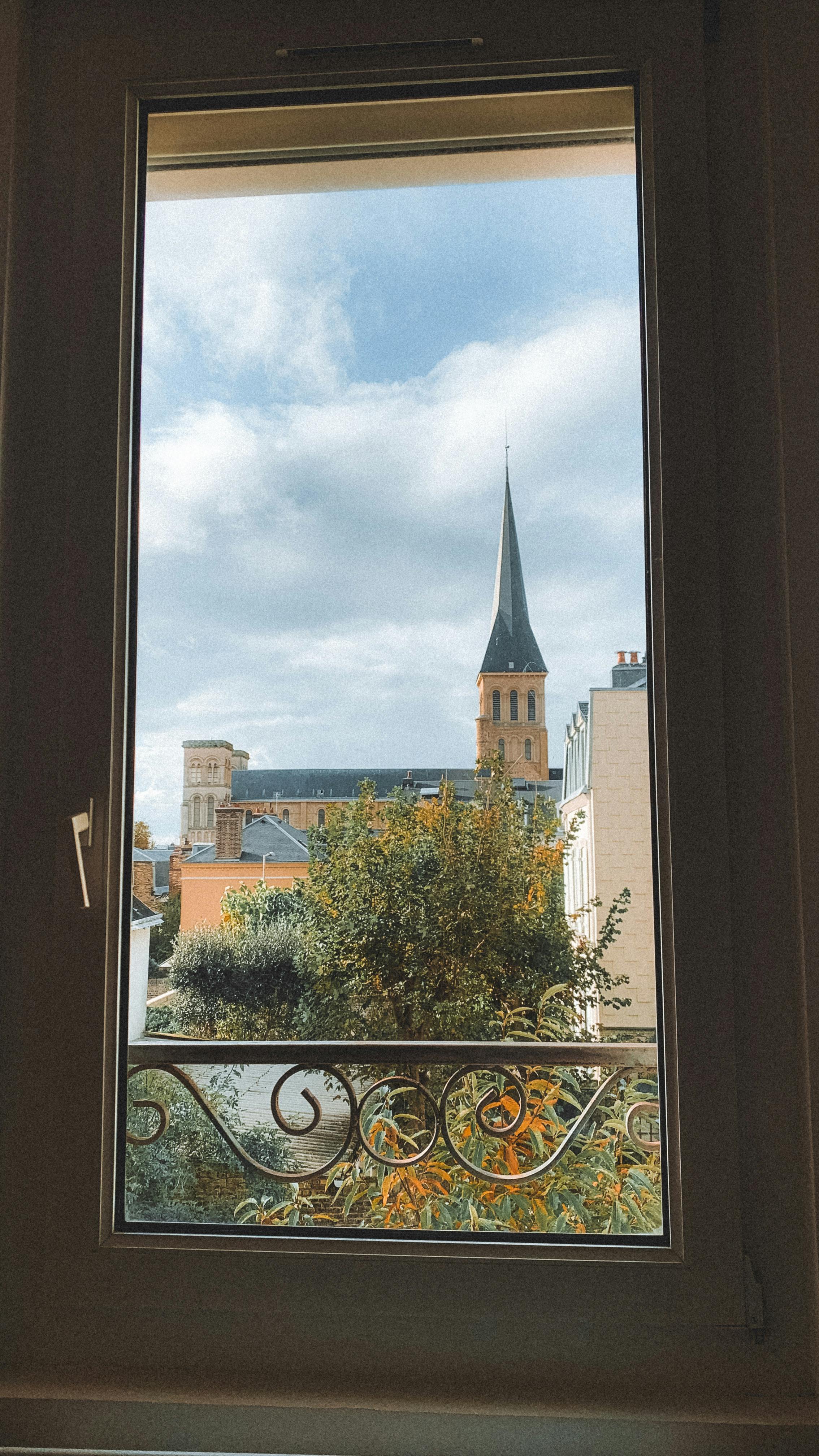 View of Historic Church Spire through Window · Free Stock Photo