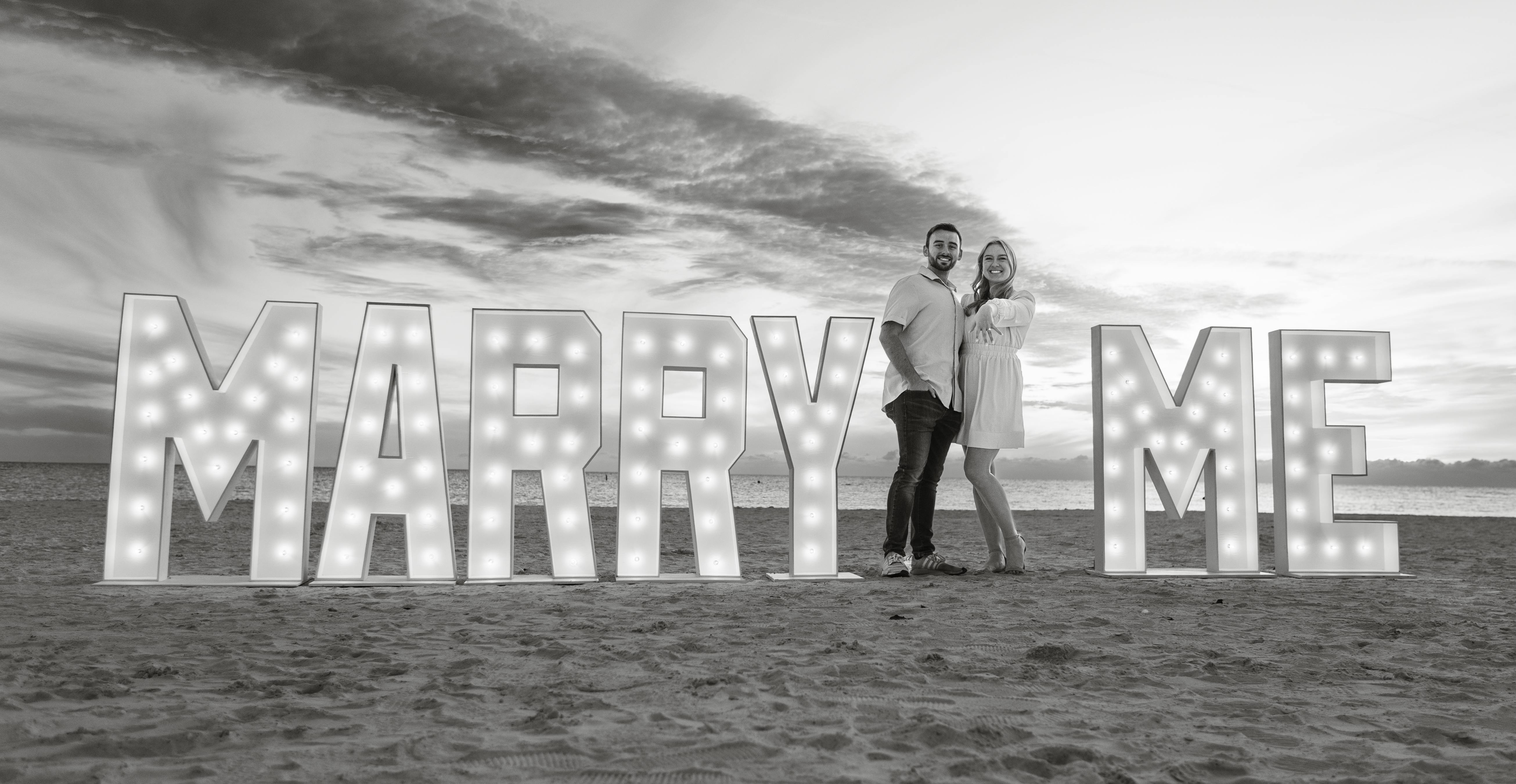 Romantic Beach Proposal with Marry Me Lights · Free Stock Photo