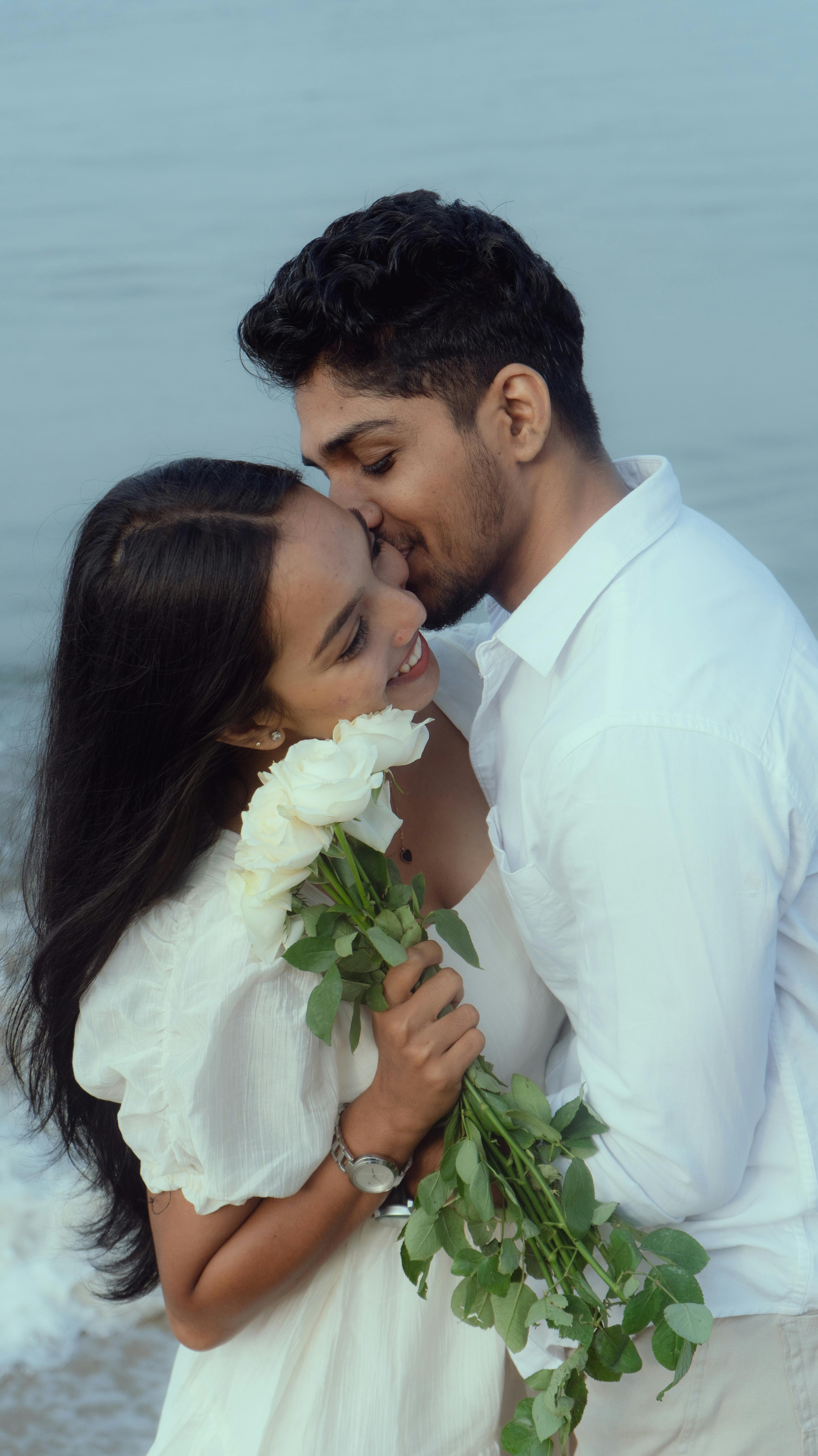 Romantic Couple Embracing on the Beach · Free Stock Photo
