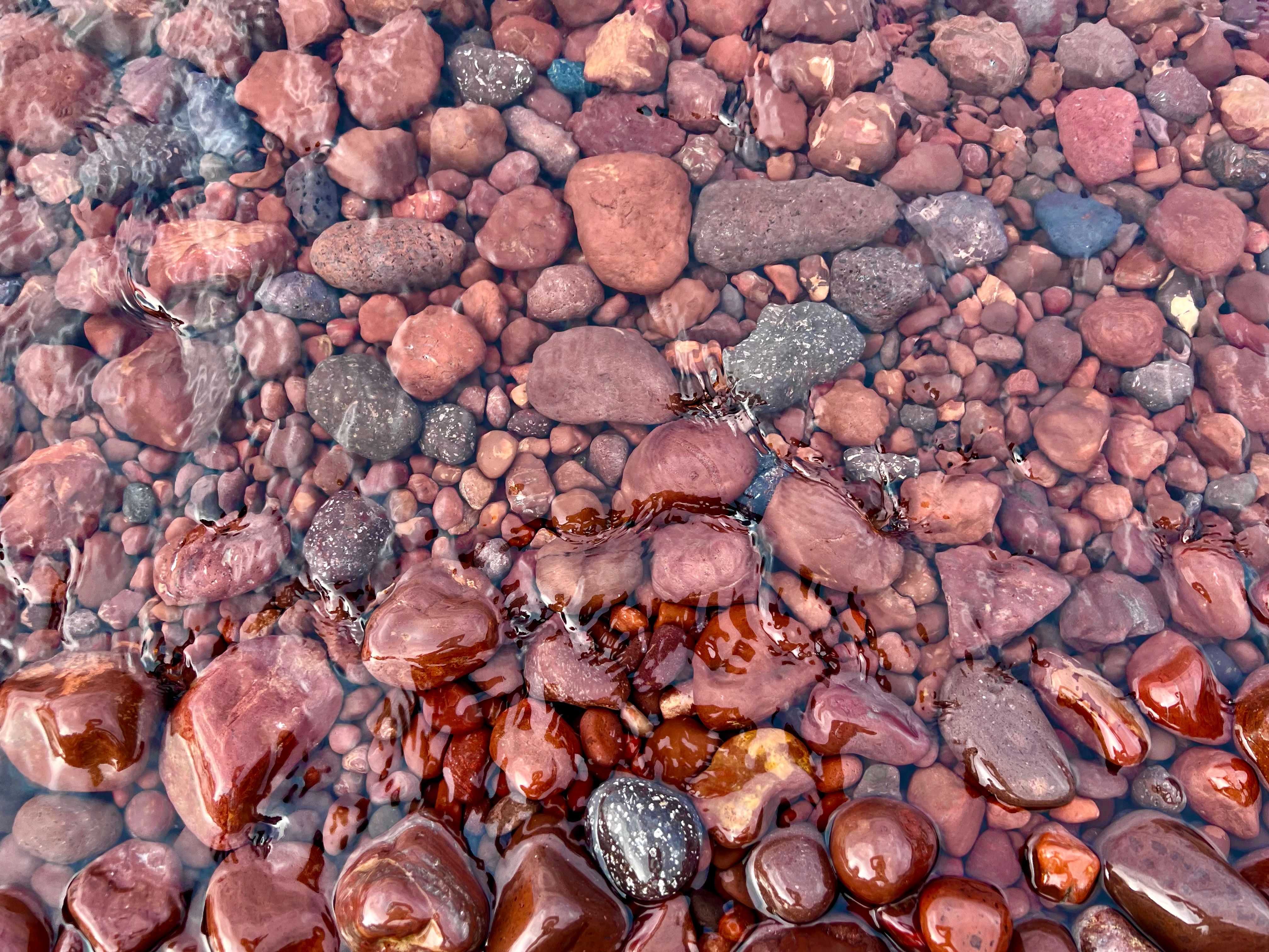 Colorful Polished Stones at Copper Harbor Shore · Free Stock Photo