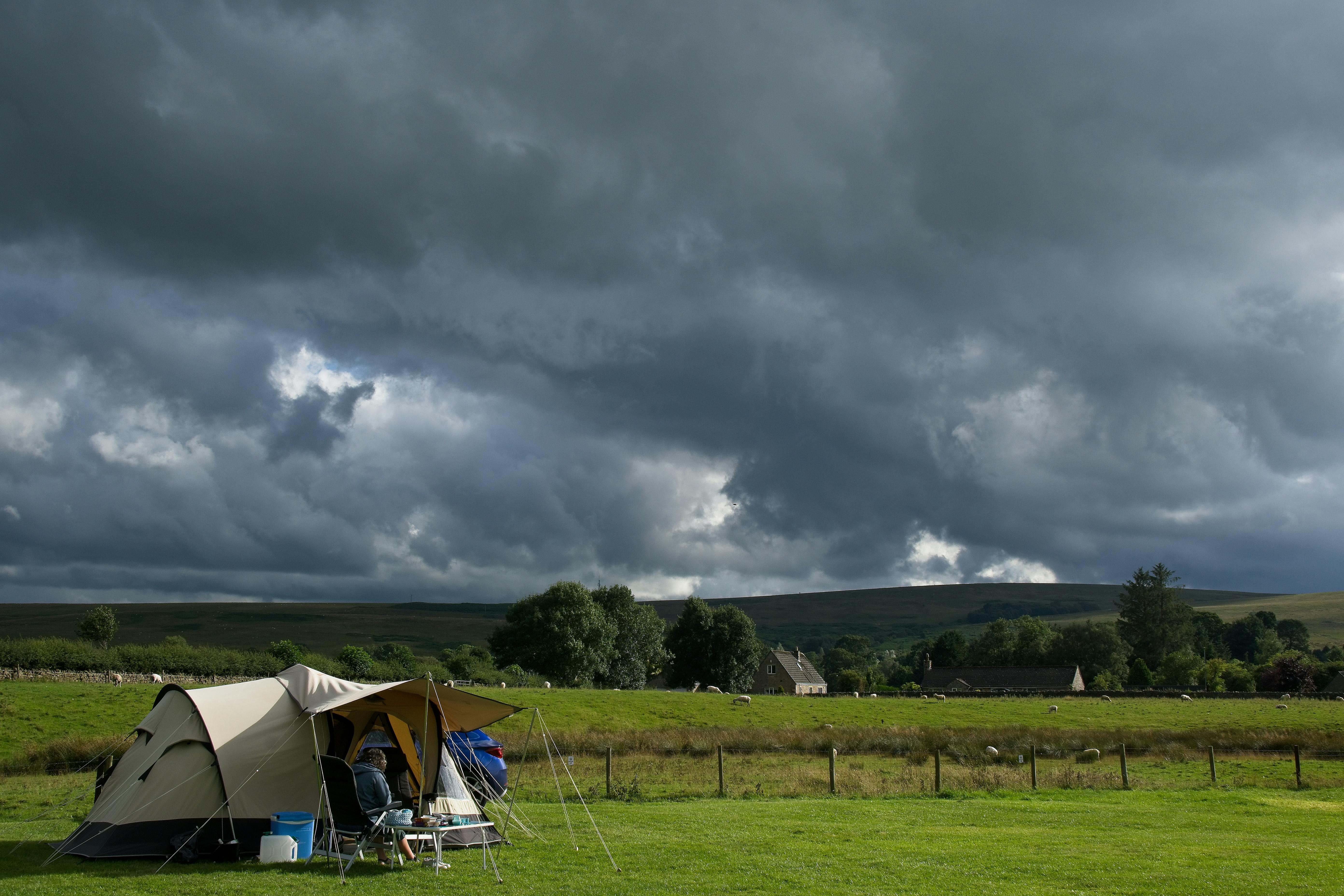 Camping Scene Under Looming Storm Clouds in England · Free Stock Photo