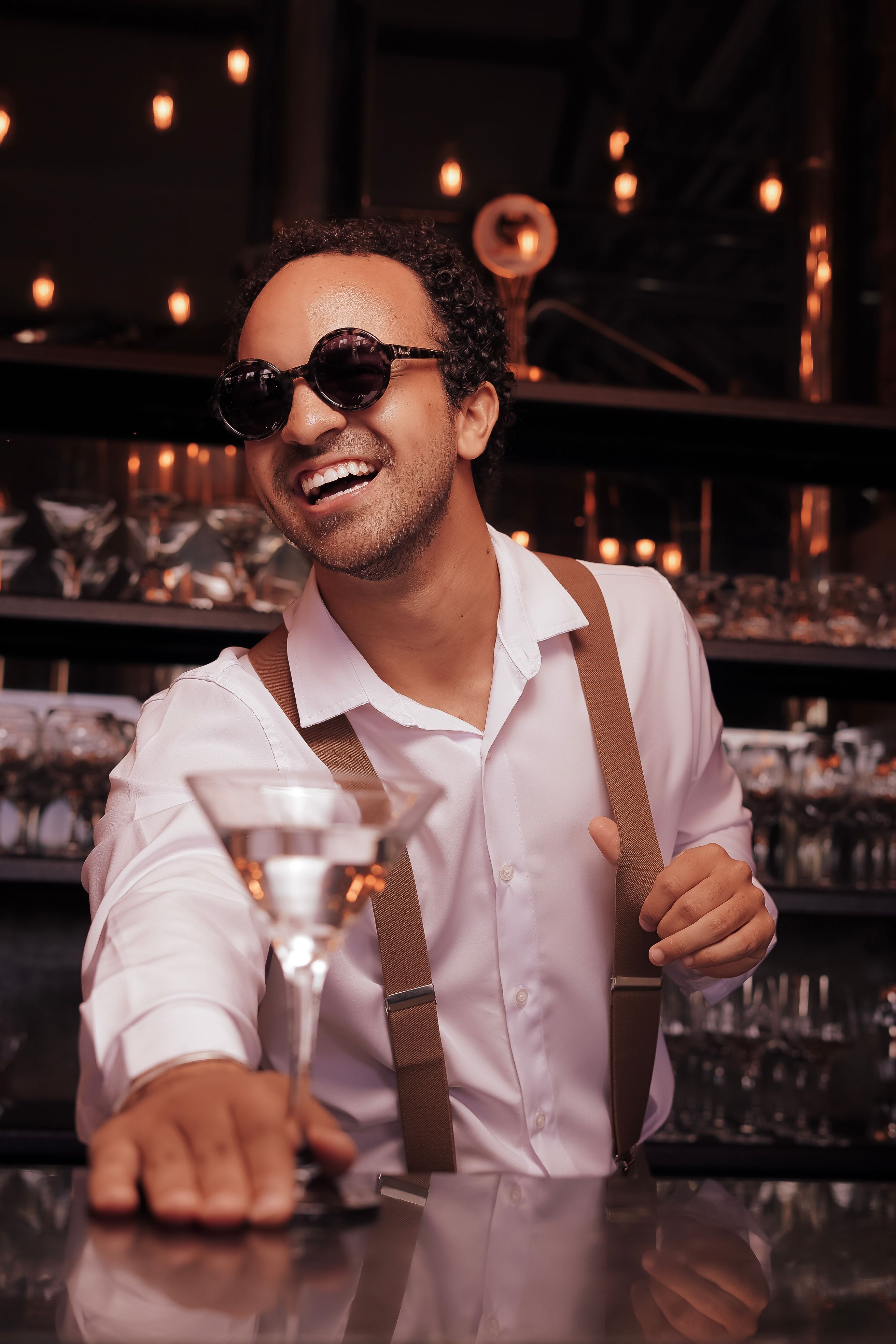 Charming Bartender Offering Martini at Stylish Bar · Free Stock Photo