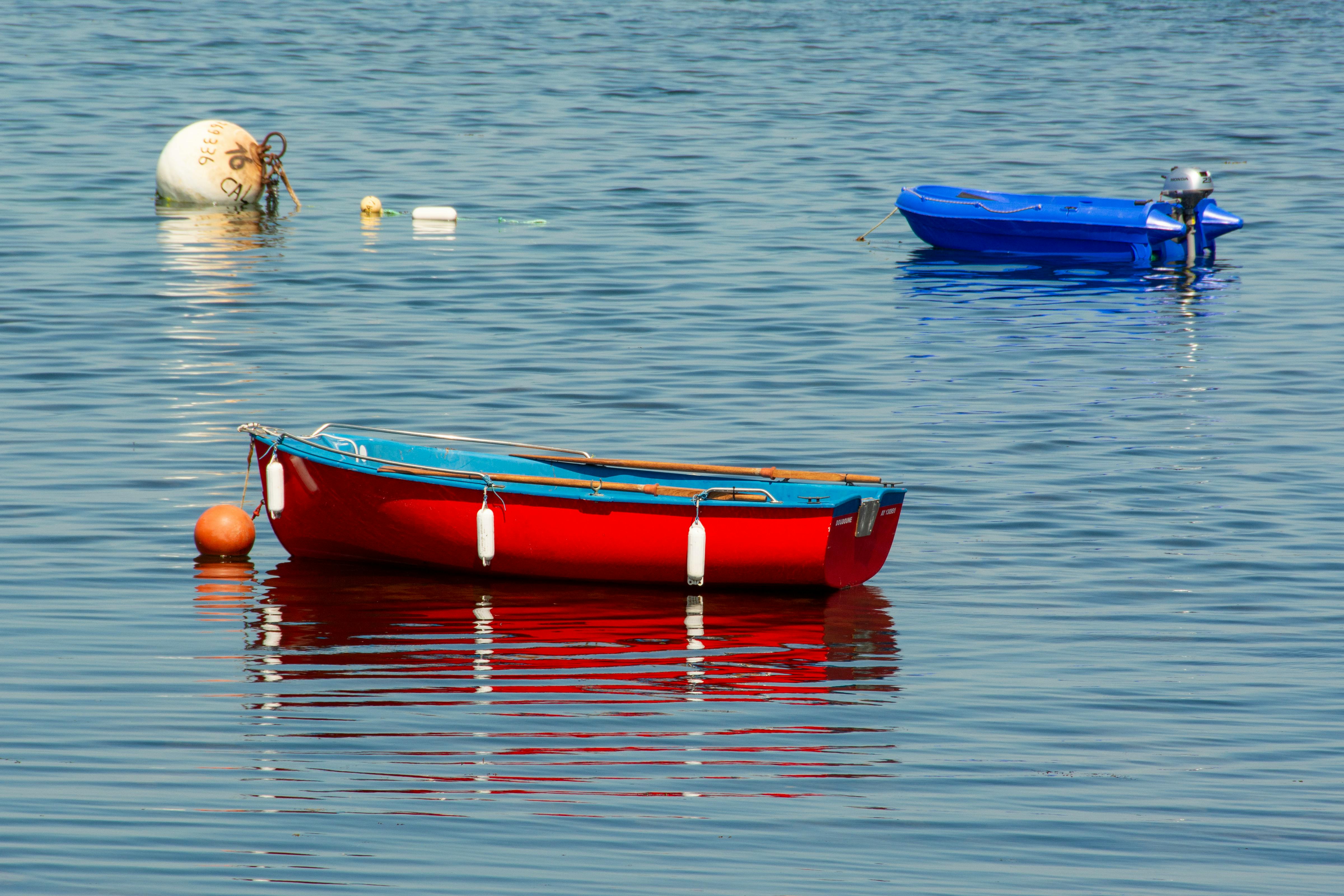 Colorful Rowboat Floating in Tranquil Waters · Free Stock Photo