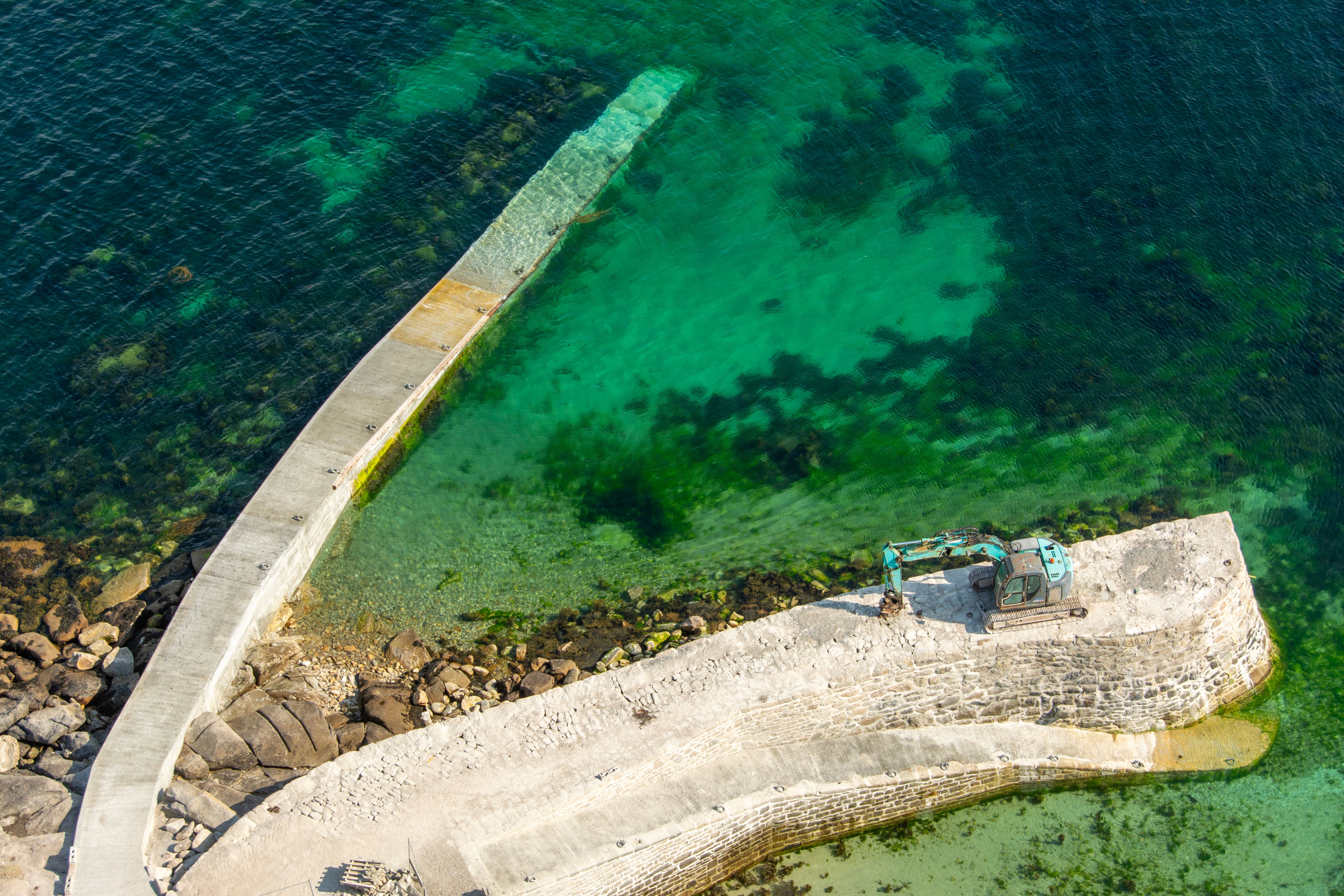 Aerial View of Coastal Pier and Excavator by the Sea · Free Stock Photo