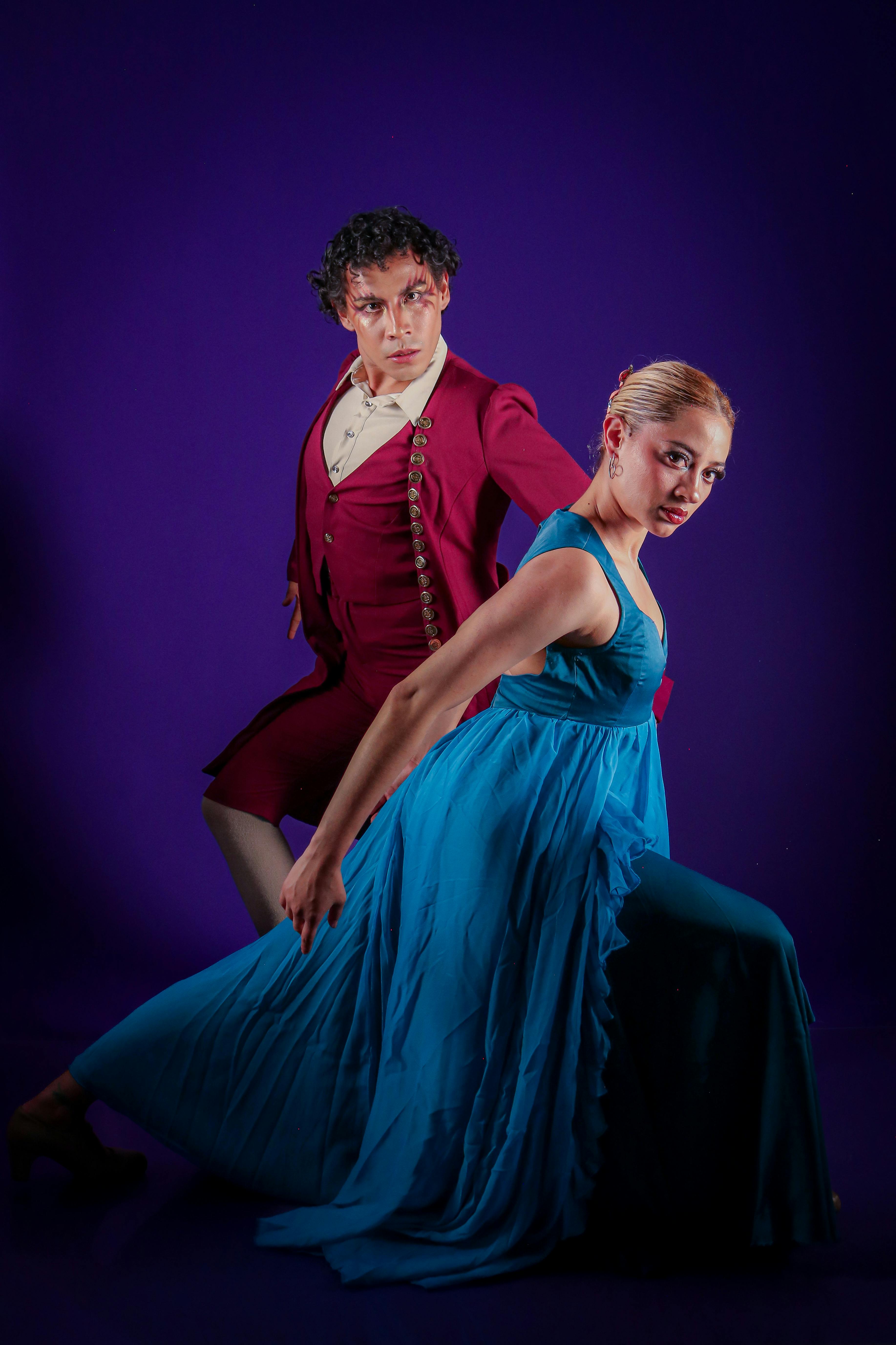 Elegant Dance Duet Captured Against Purple Backdrop · Free Stock Photo