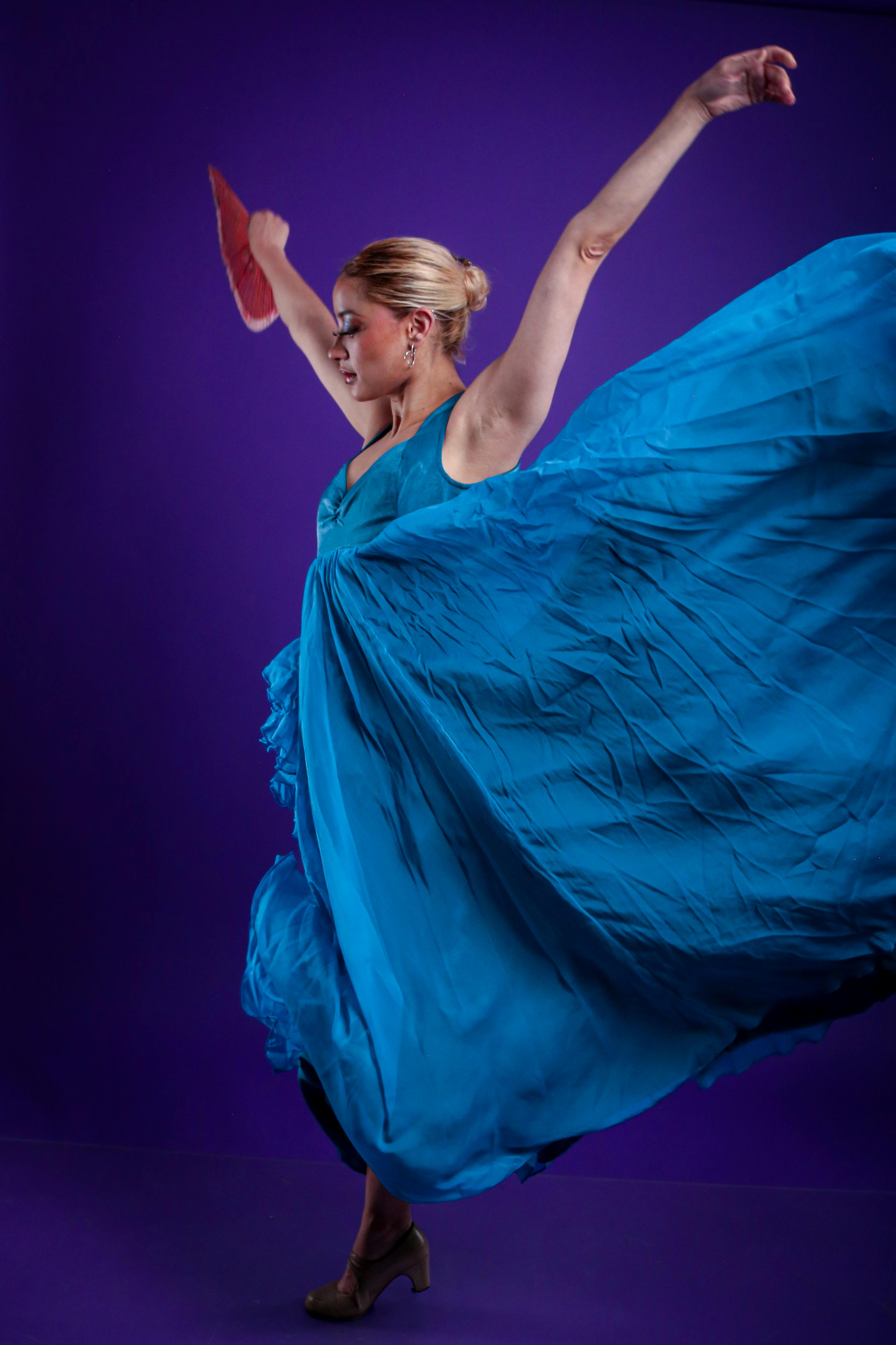 Elegant Woman Dancing in Flowing Blue Dress · Free Stock Photo