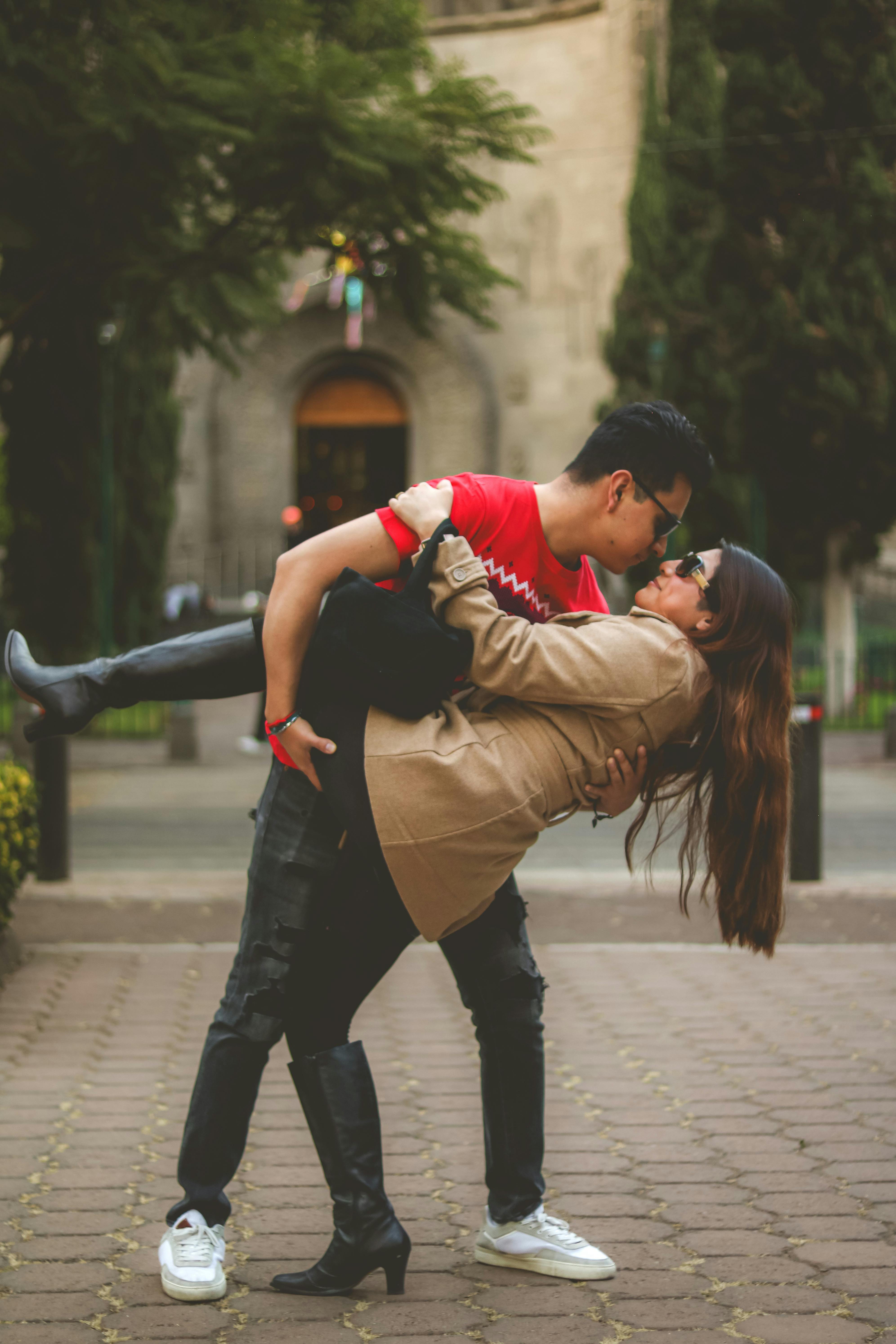 Couple Embracing Outdoors in Romantic Dance Pose · Free Stock Photo