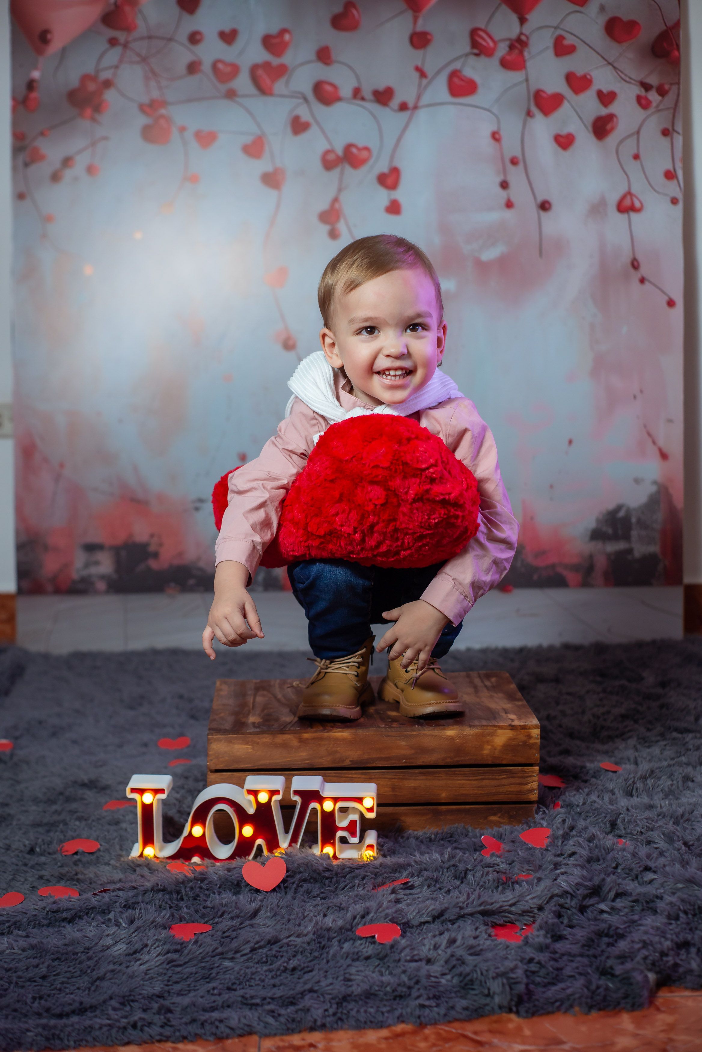 Cute Child Holding Heart in Valentine's Setup · Free Stock Photo