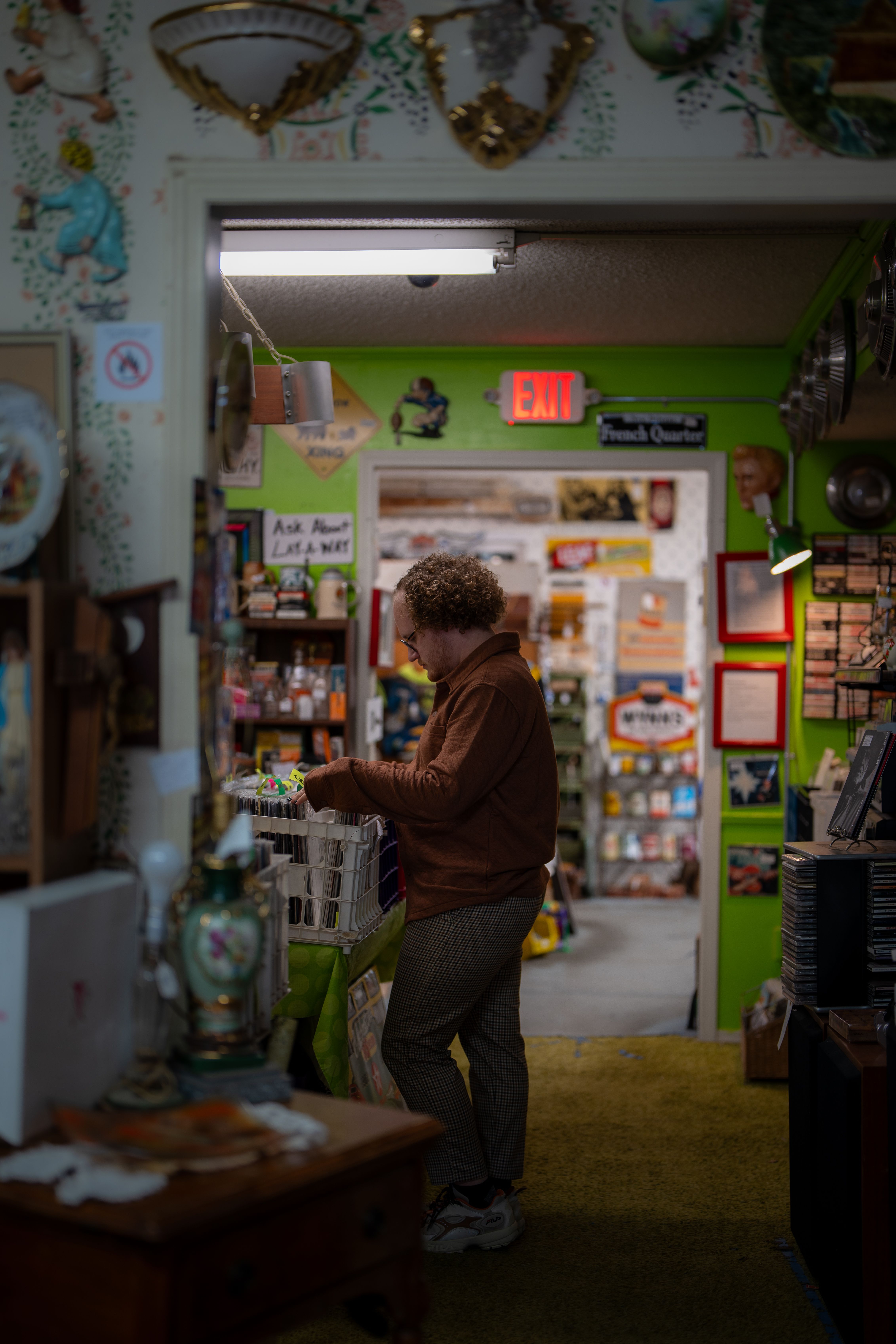 Vintage Shop Interior with Person Browsing · Free Stock Photo