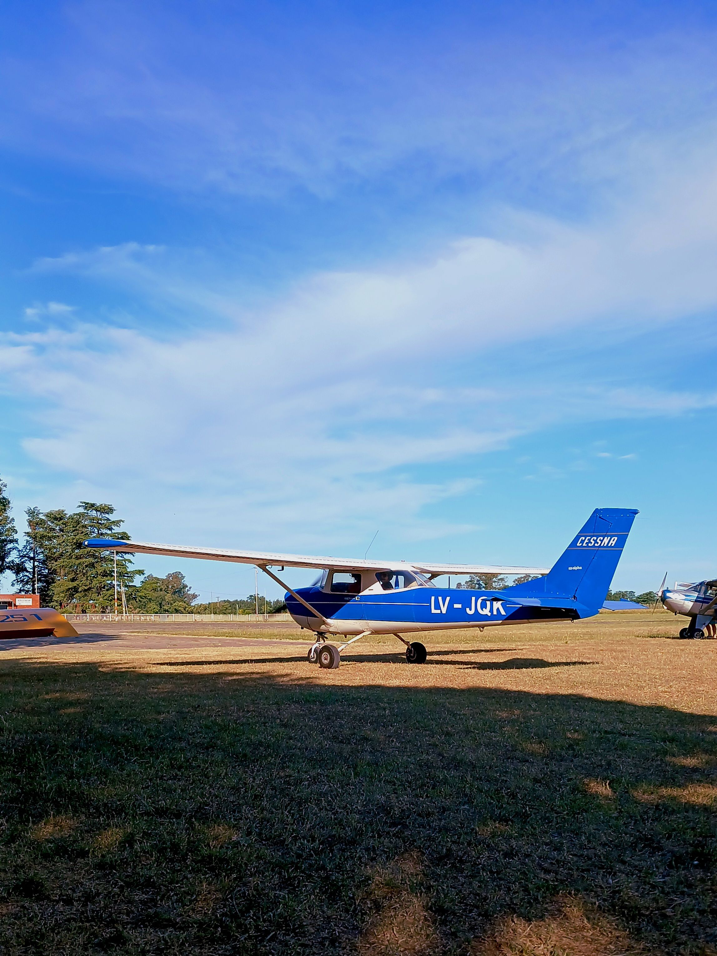 Blue Cessna Airplane at Rural Airfield on Sunny Day · Free Stock Photo