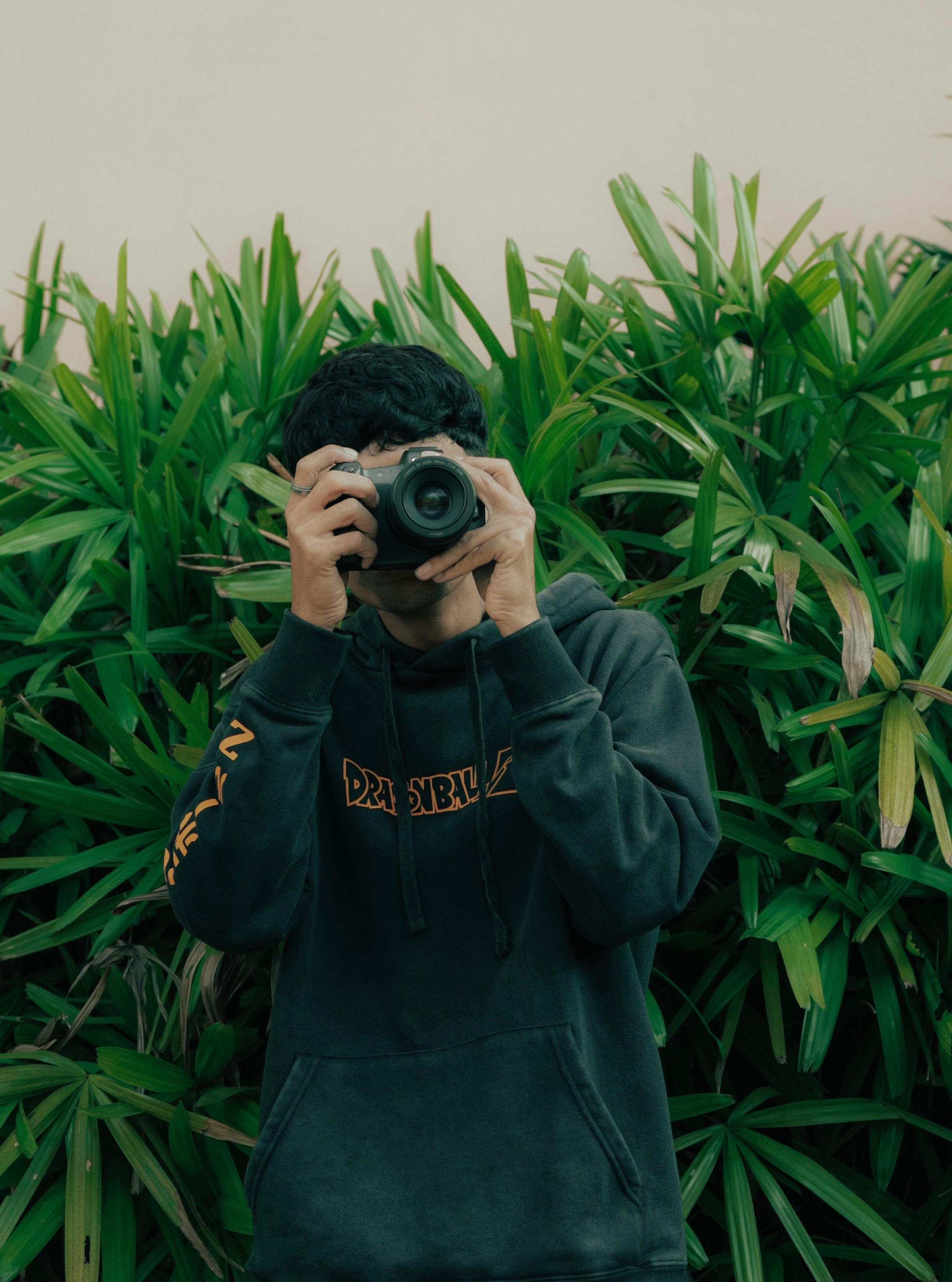 Young Photographer with Camera in Greenery · Free Stock Photo