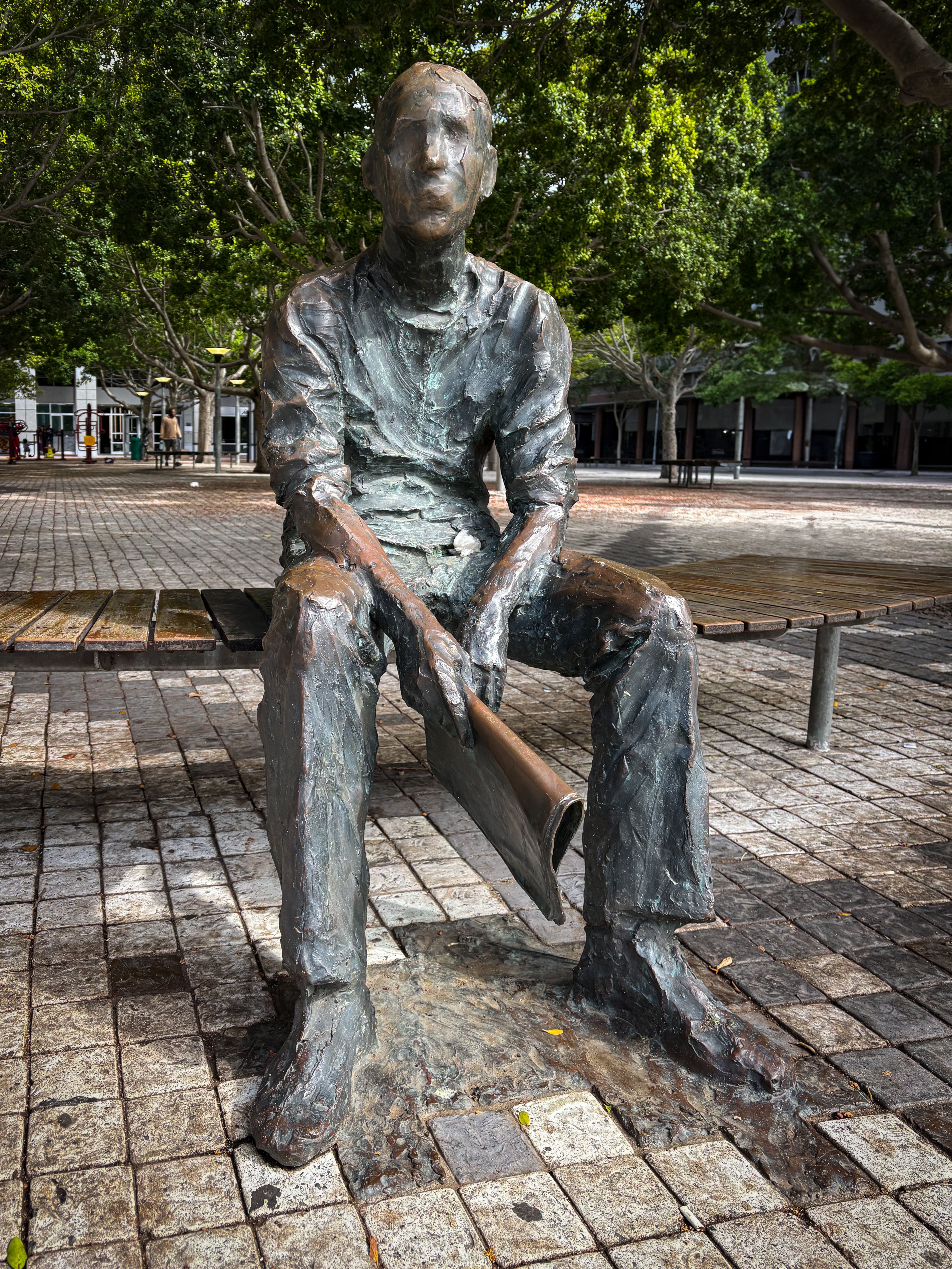Bronze Statue of Man Sitting in Public Plaza · Free Stock Photo