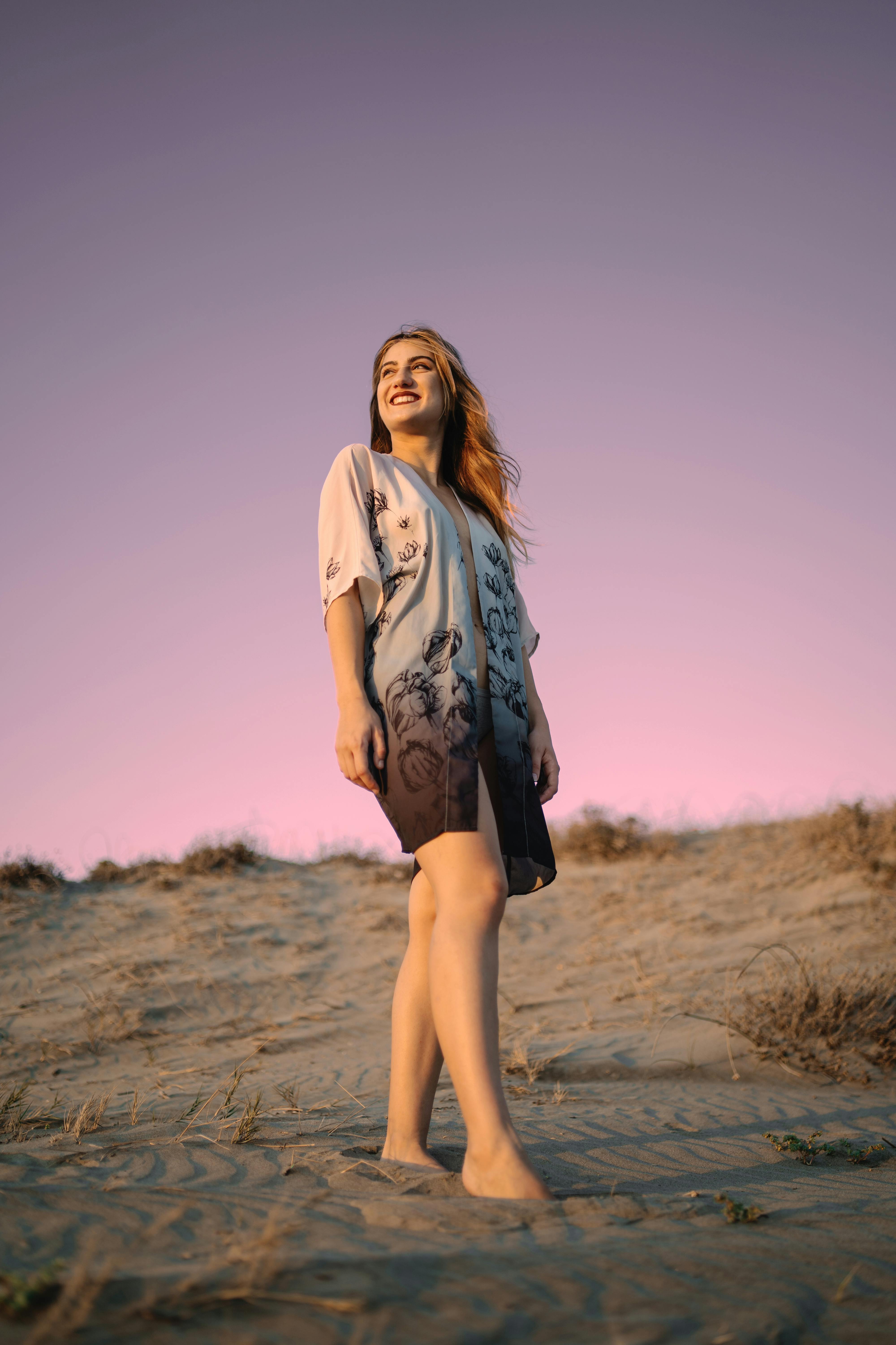 Low Angle Photography Of Woman Standing On Sand · Free Stock Photo
