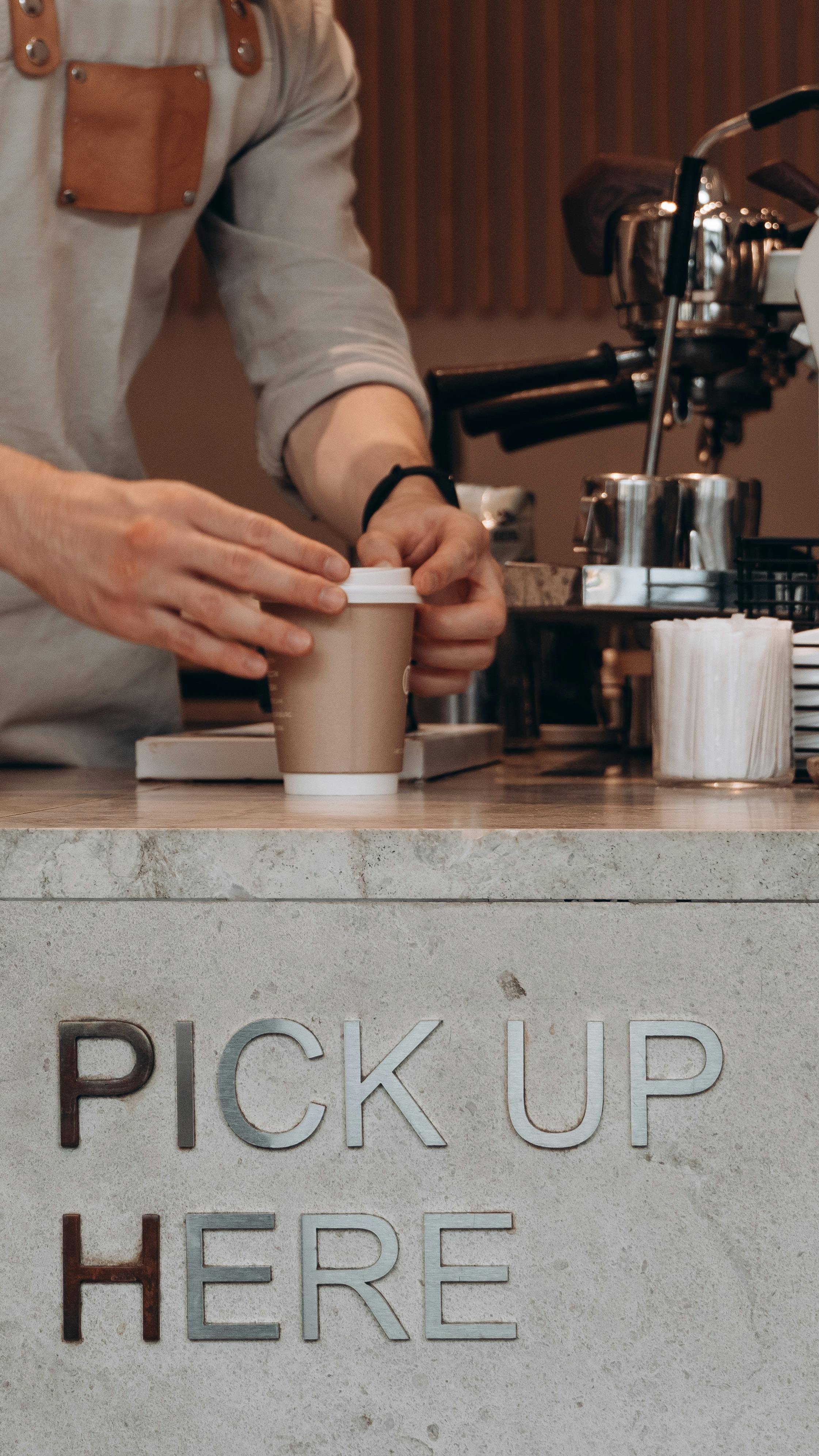 Barista Preparing Coffee at Pick Up Station · Free Stock Photo