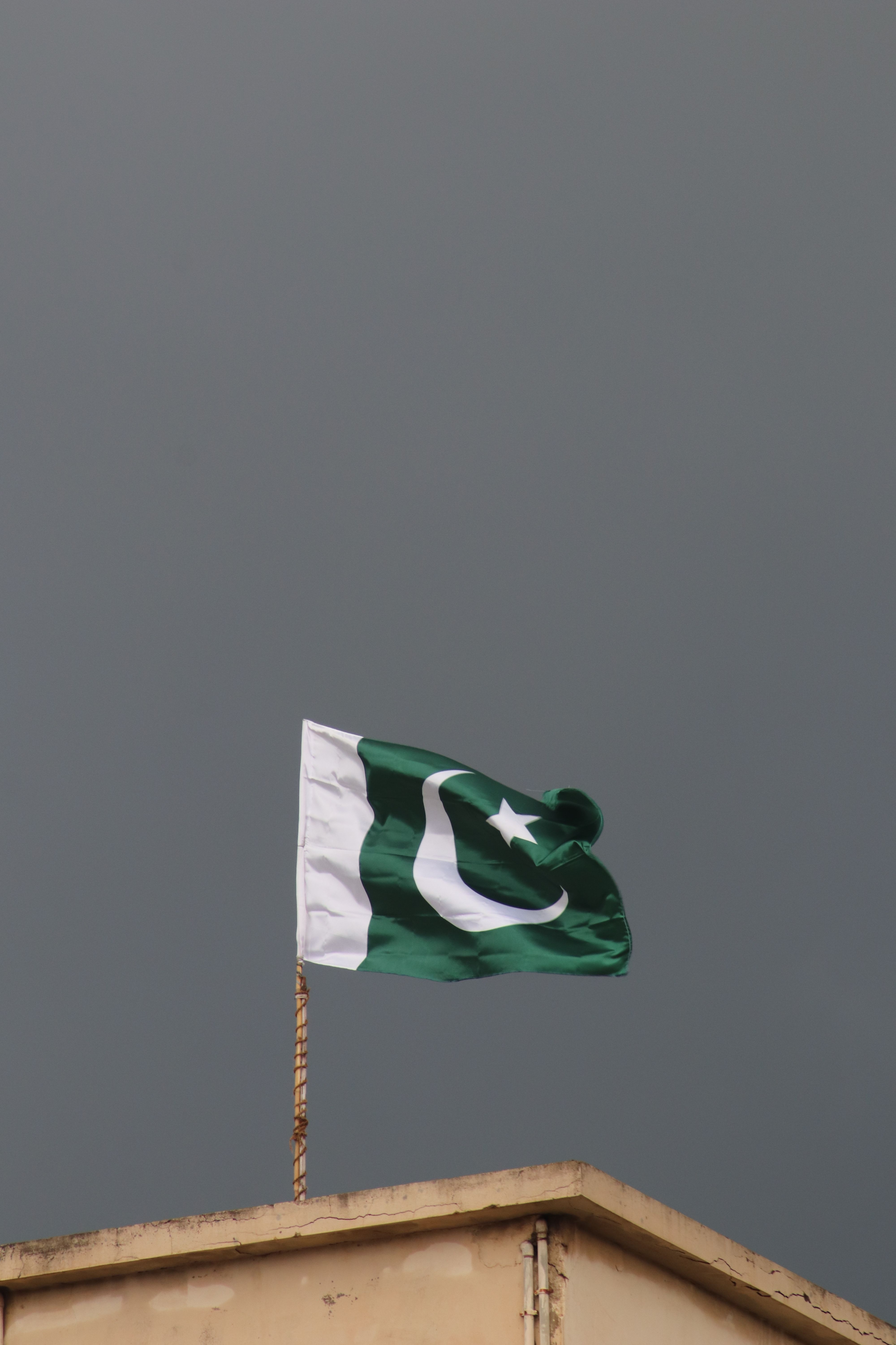 Pakistani Flag Against Stormy Sky · Free Stock Photo