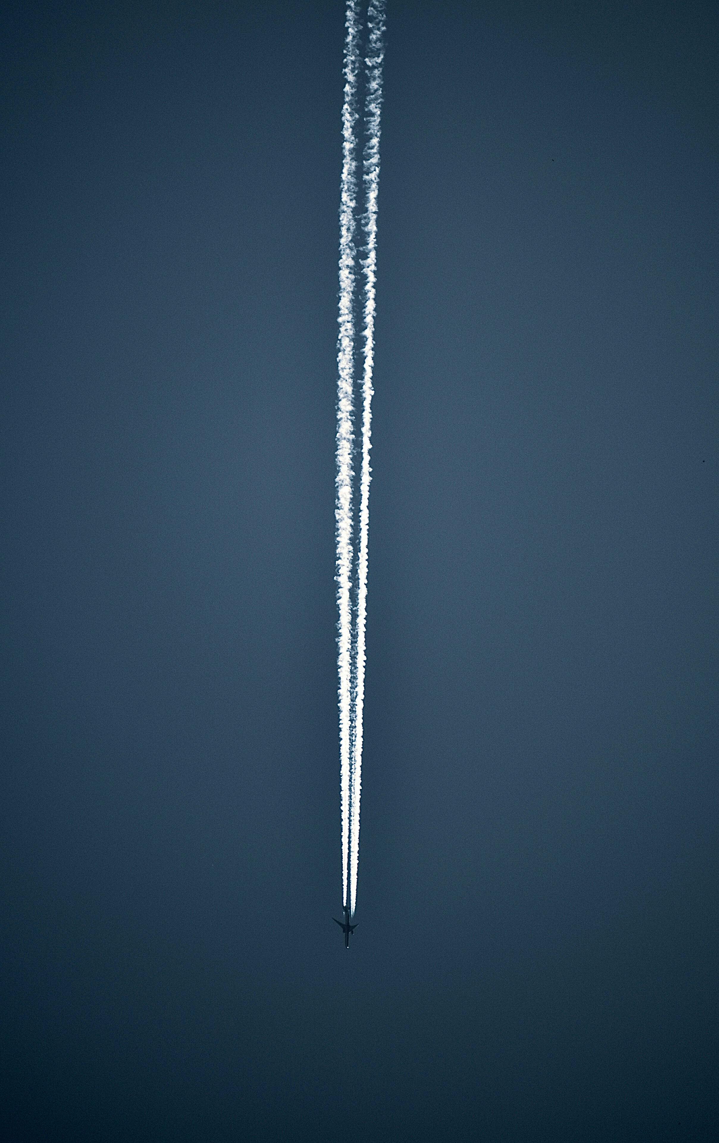 High Altitude Jet with Contrail in Clear Sky · Free Stock Photo