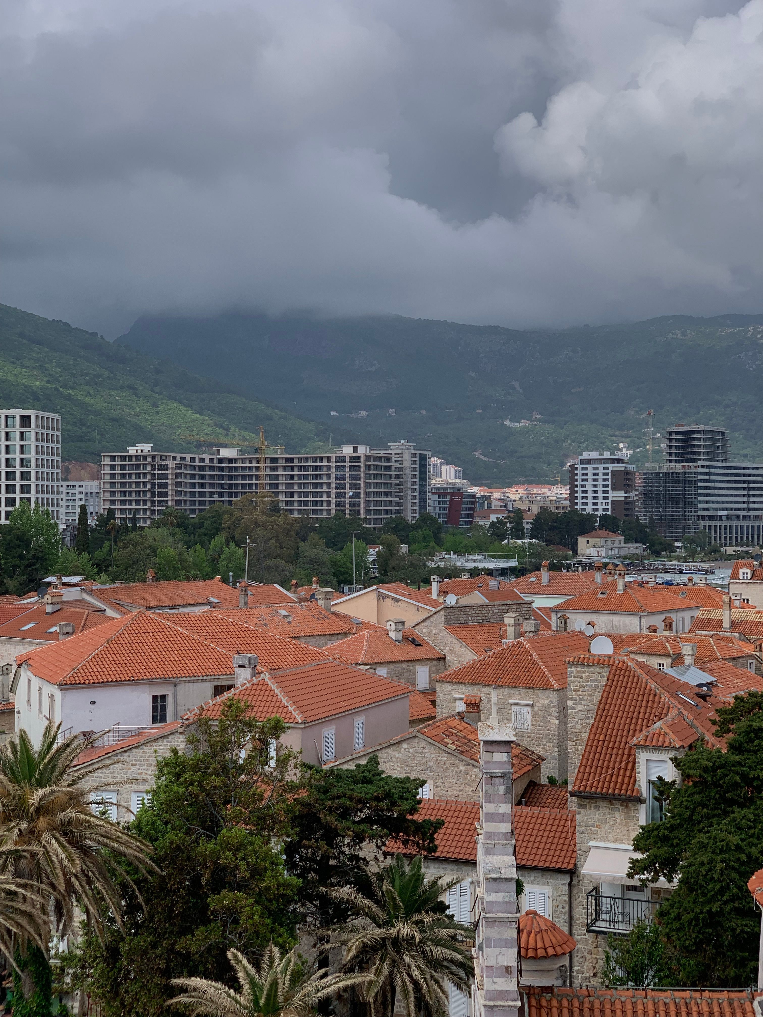 Scenic Rooftop View of Coastal Town and Mountains · Free Stock Photo