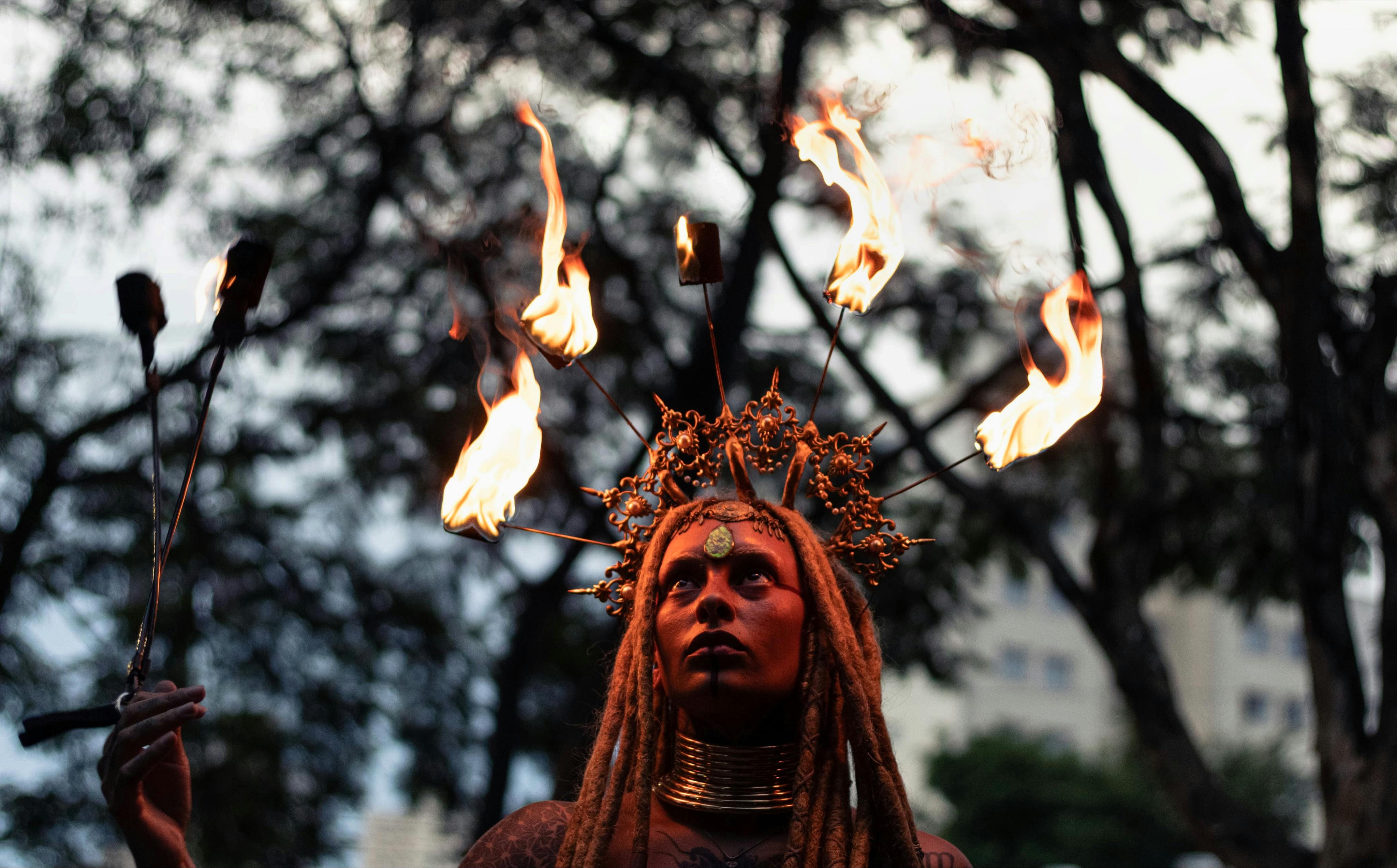 Fire Performer with Flaming Crown in Outdoor Setting · Free Stock Photo