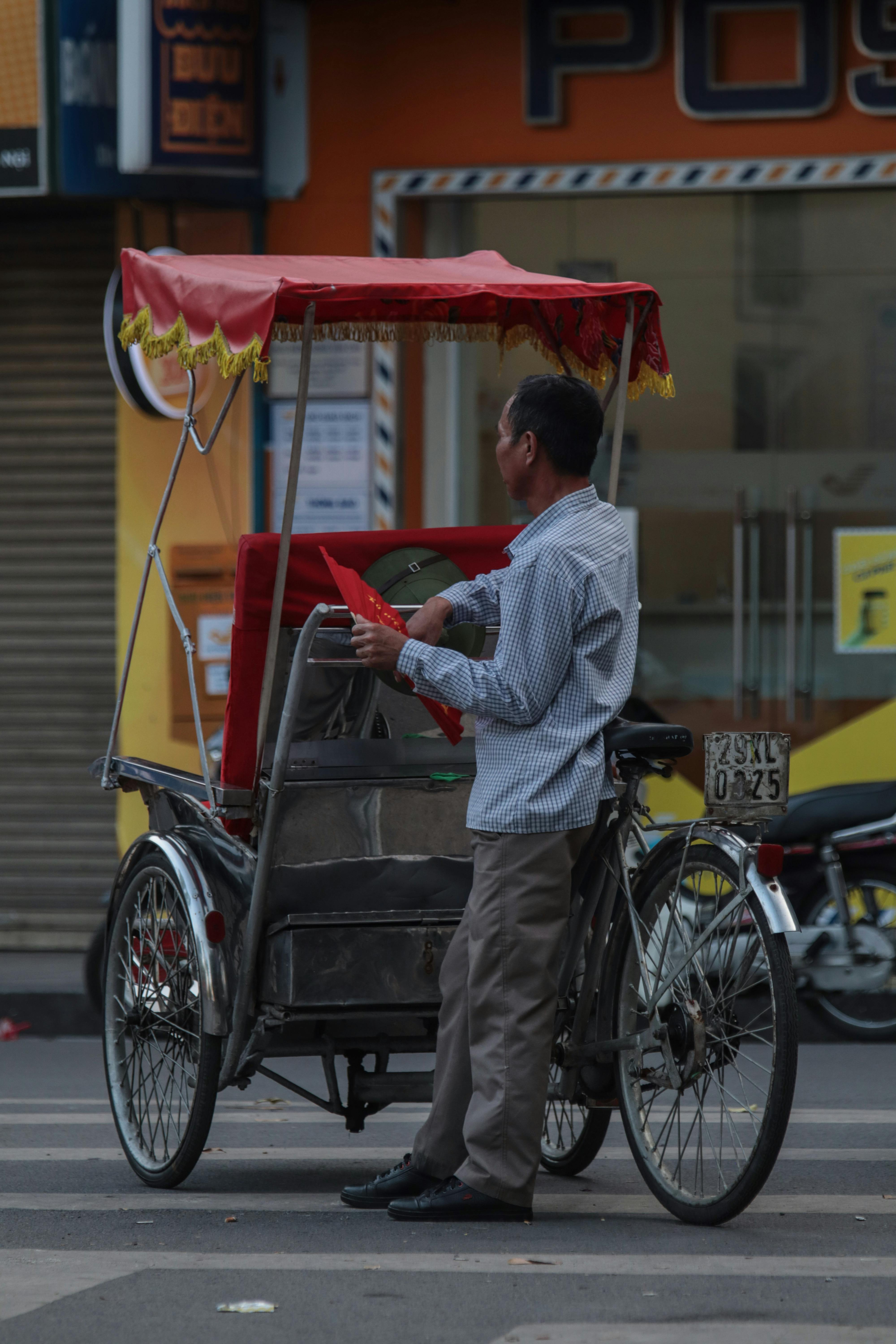 Traditional Cyclo Driver in Hanoi City · Free Stock Photo